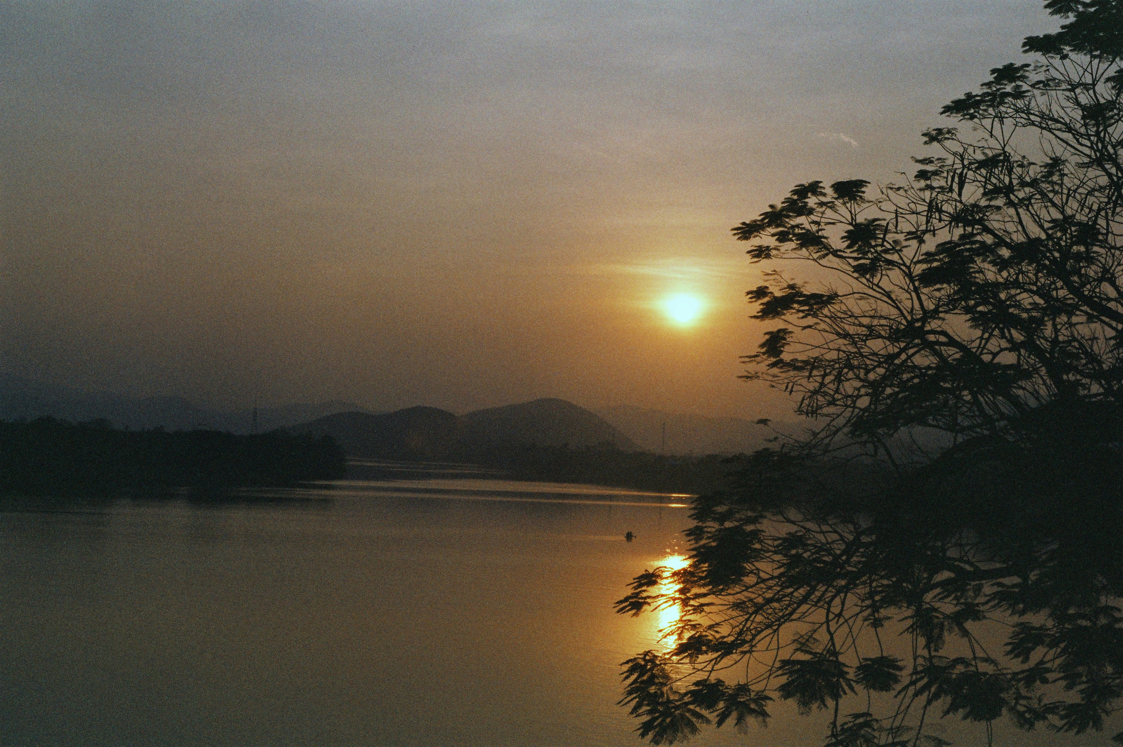 Sunset reflects on a calm body of water.