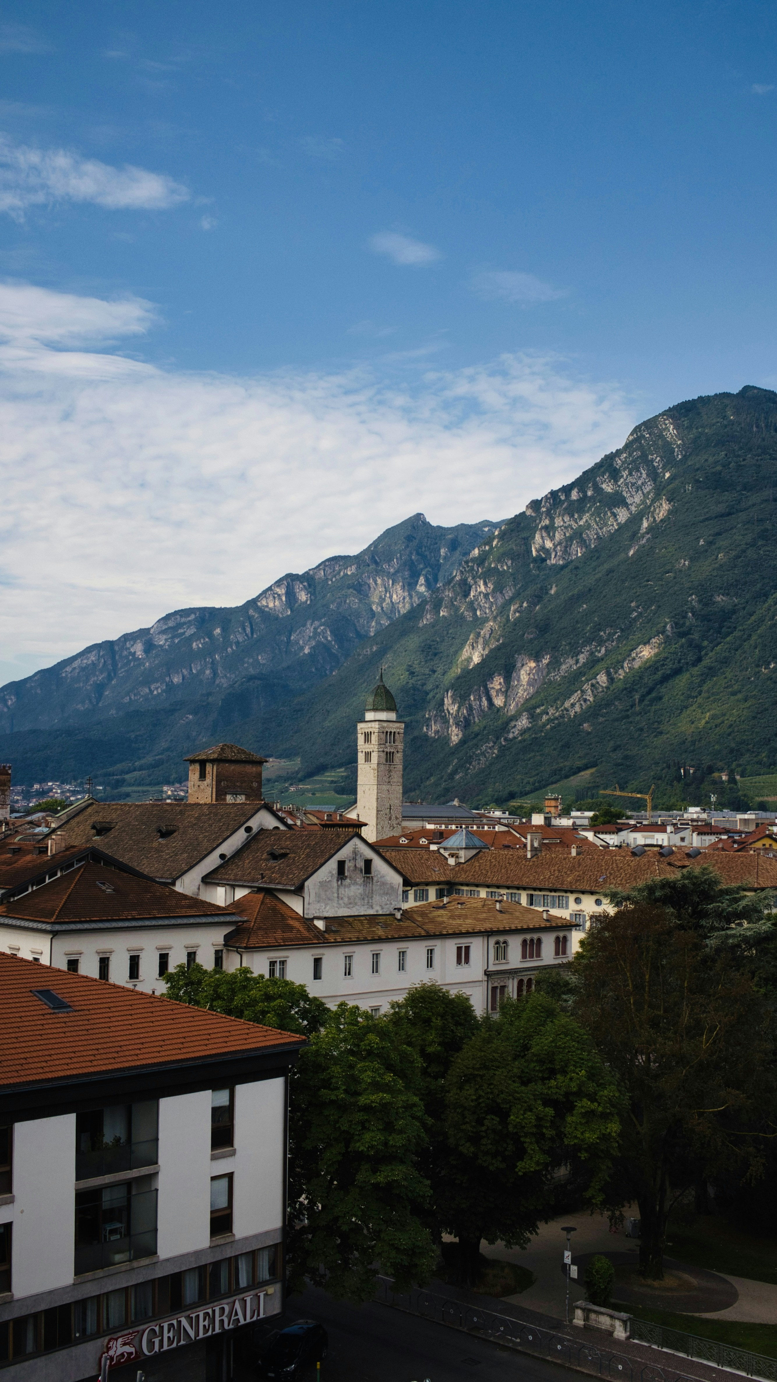 Cityscape with mountains in the background on a sunny day.