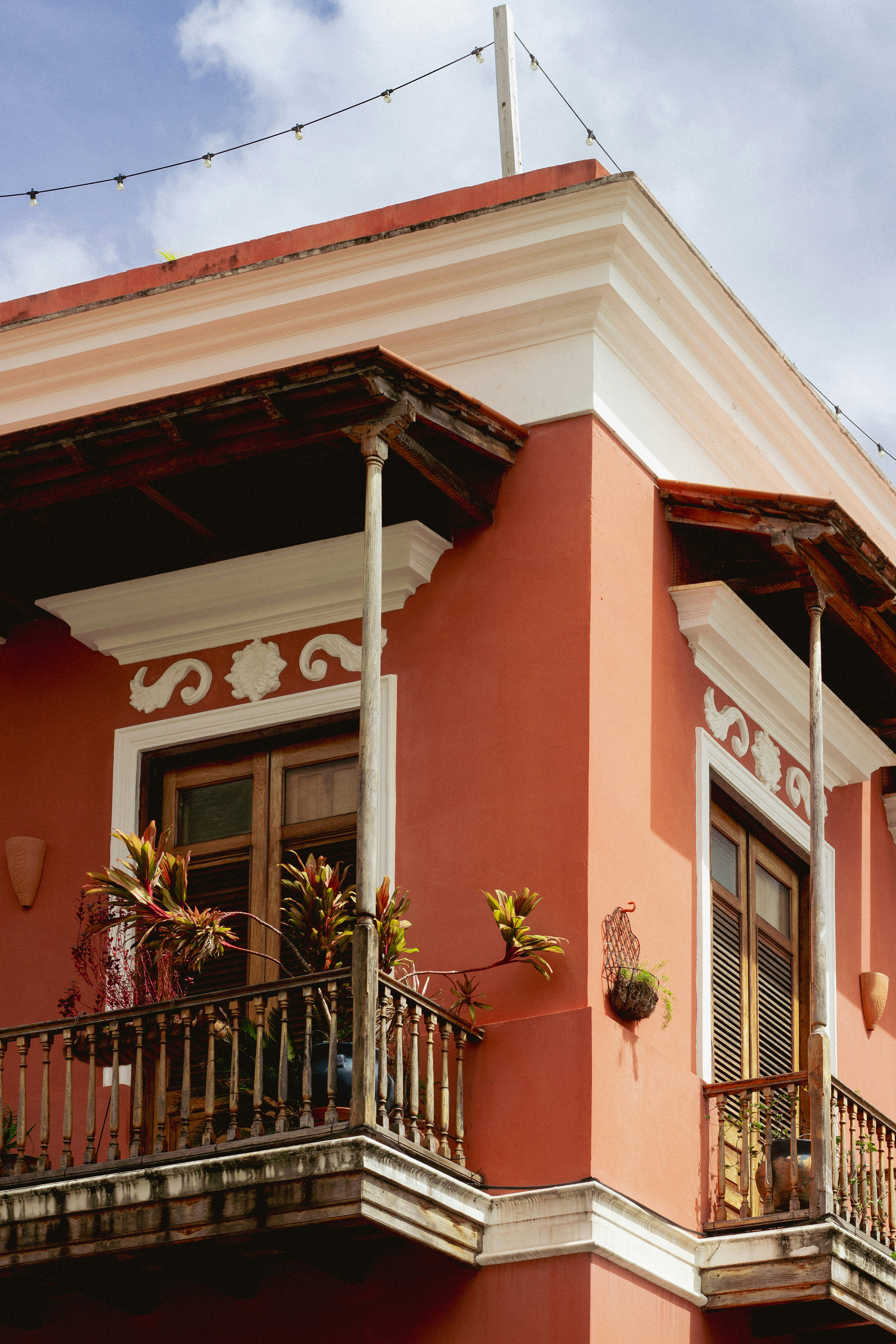 Beautiful coral building with ornate balconies and detailing. photo ...