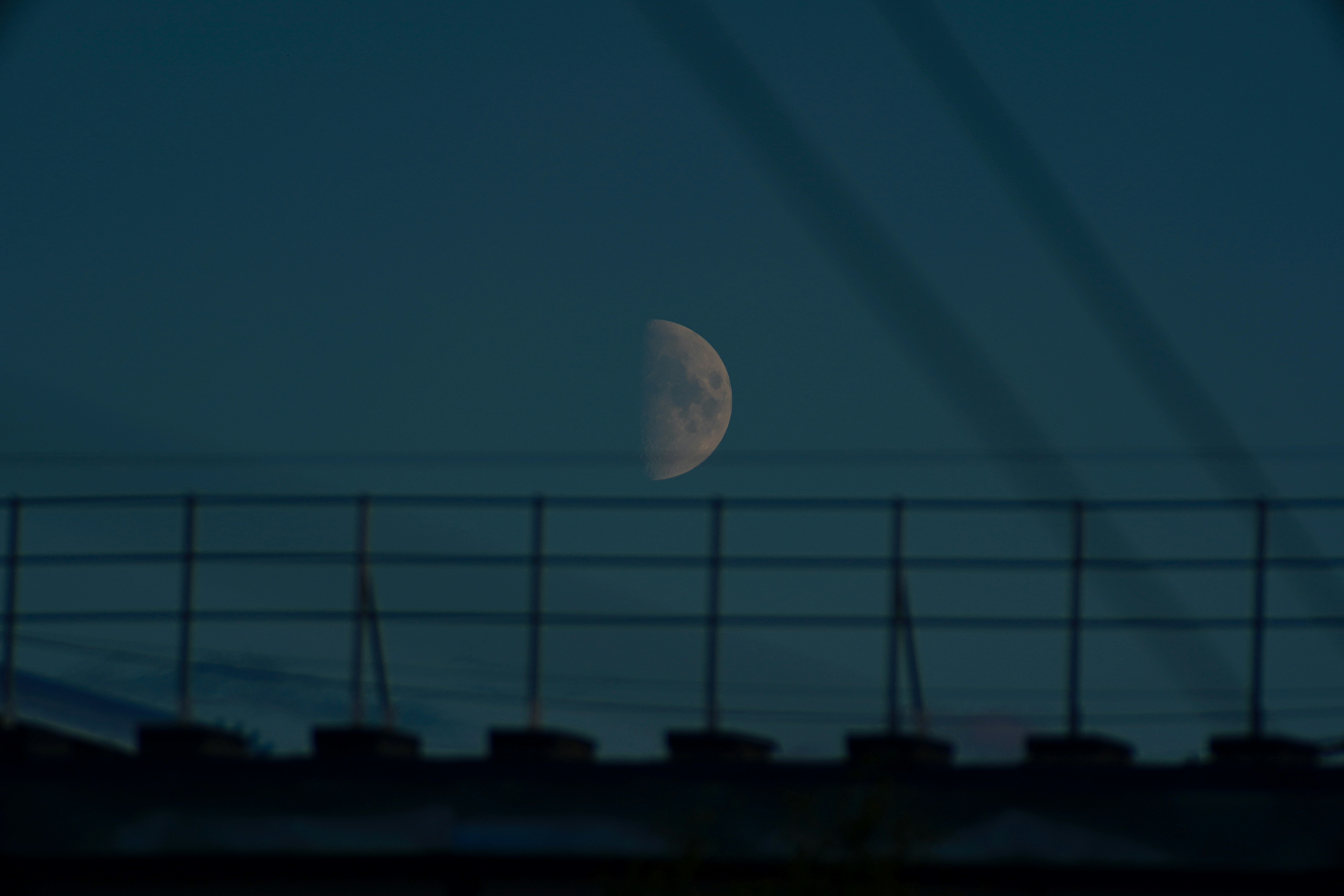 Beyond earth | The moon shines brightly in the evening sky.