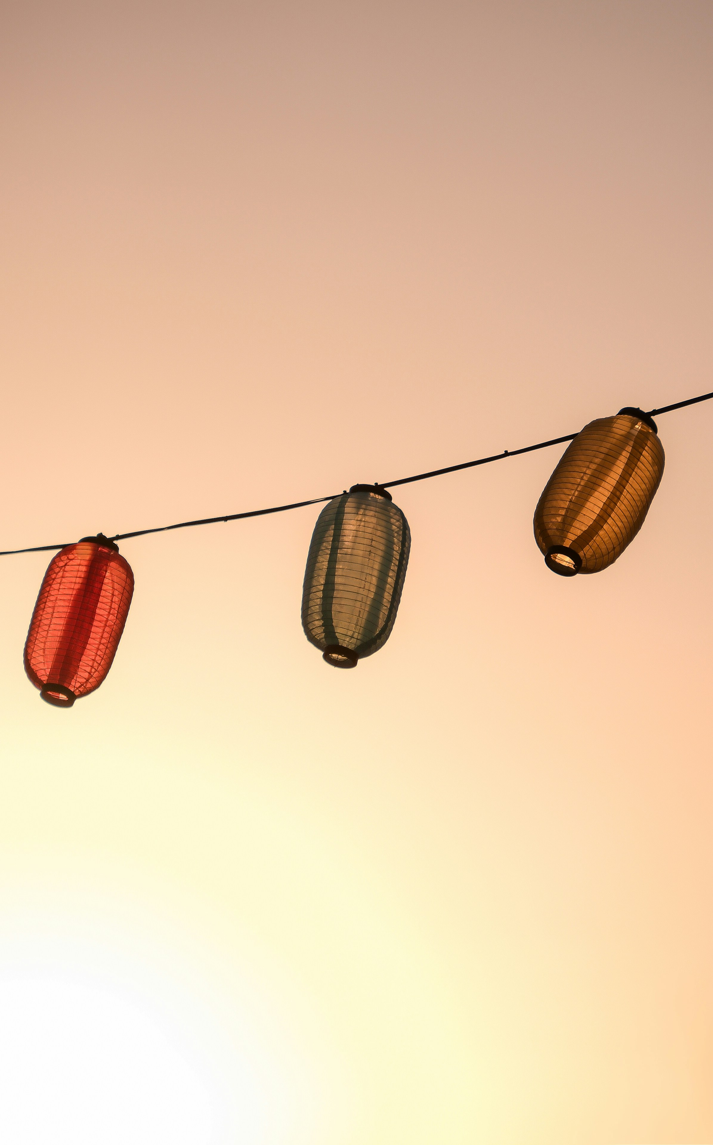 Red, Blue, and Gold: Lanterns Draped Across a Dusk Sky