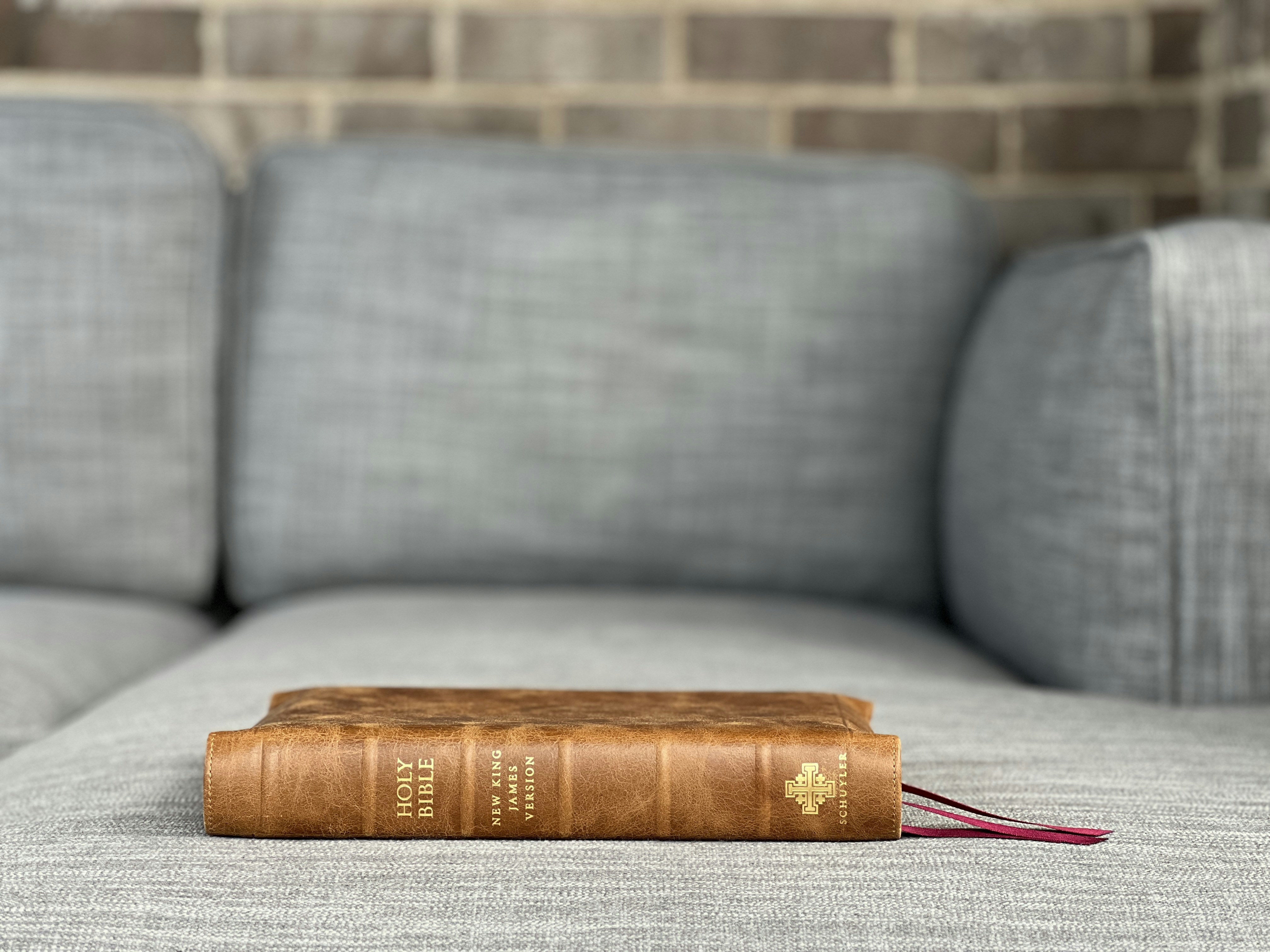 Leather Bible Resting on a Quiet Living Room Couch