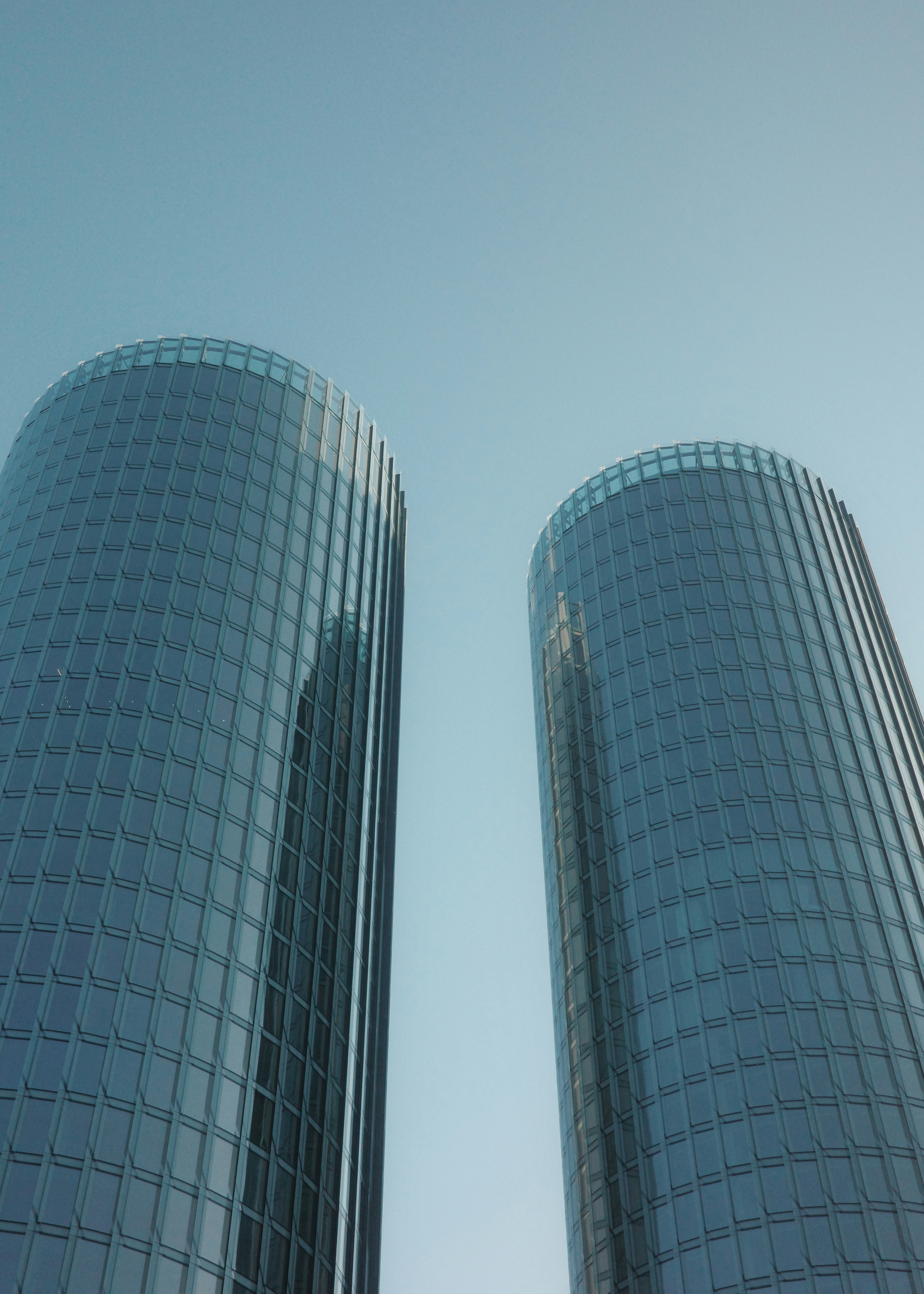 Twin Glass Giants Reach Toward an Expansive Sky