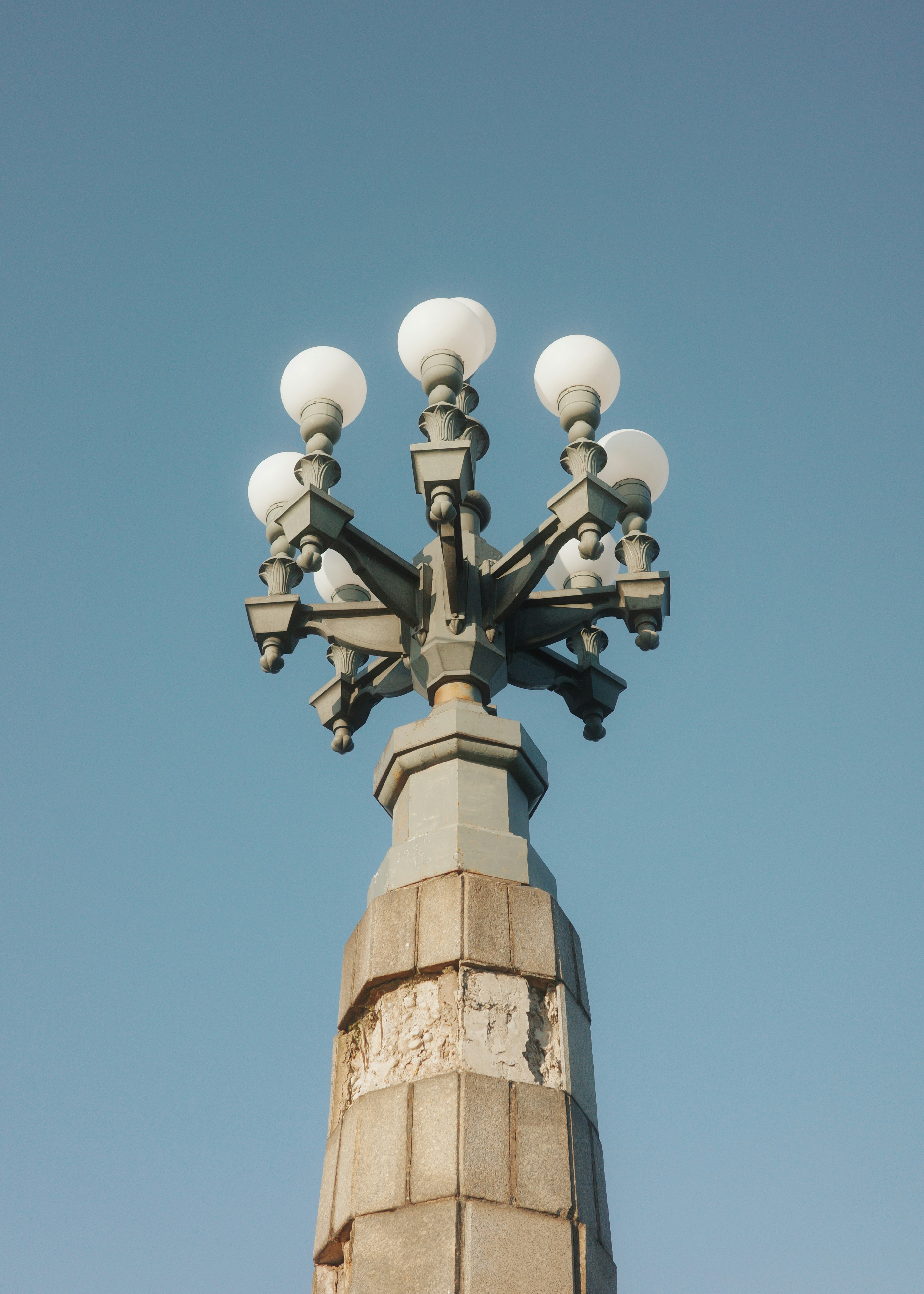 A decorative lamp post against a clear blue sky.