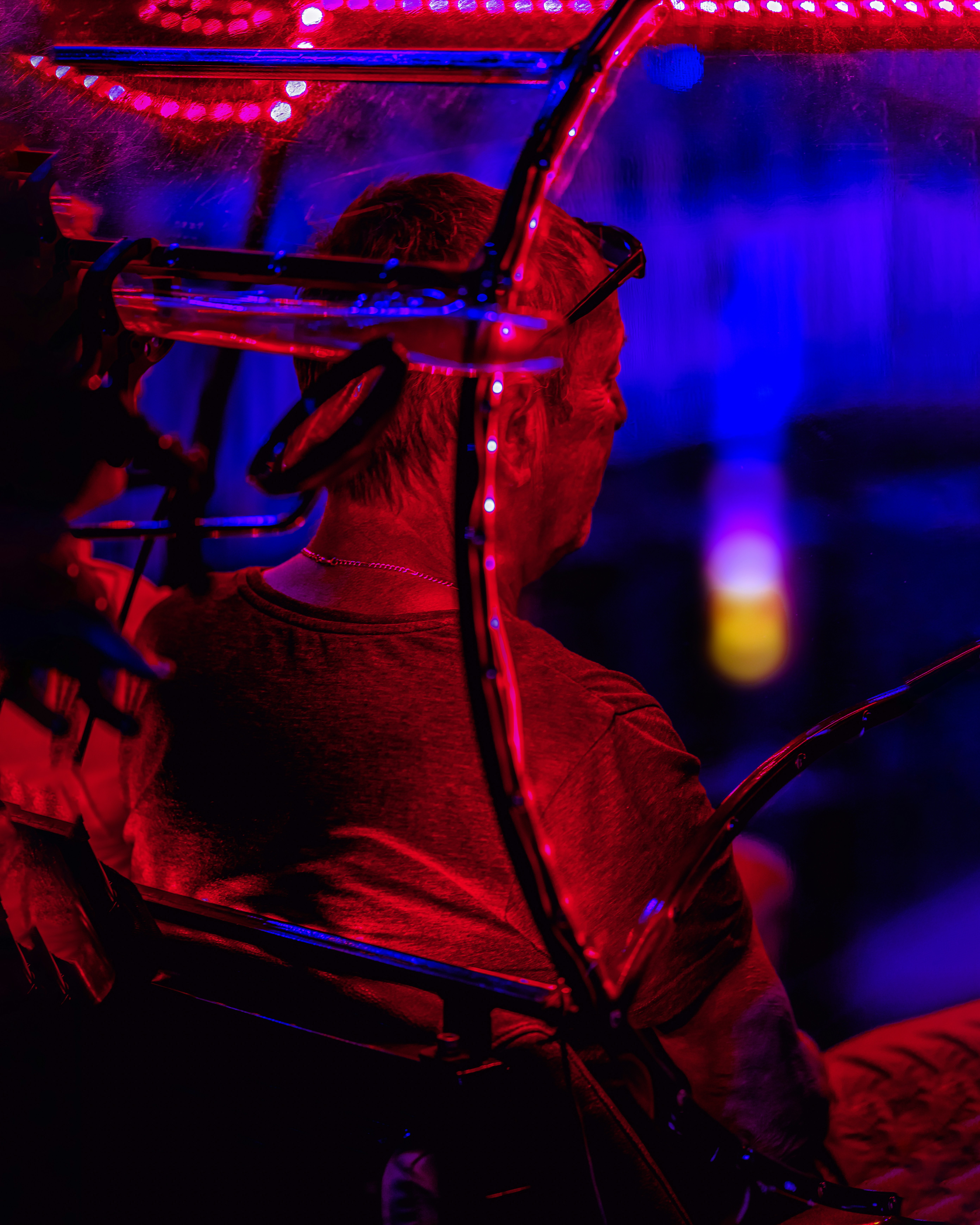 Neon Backlit in a Red-Blue Cab: A Quiet Portrait