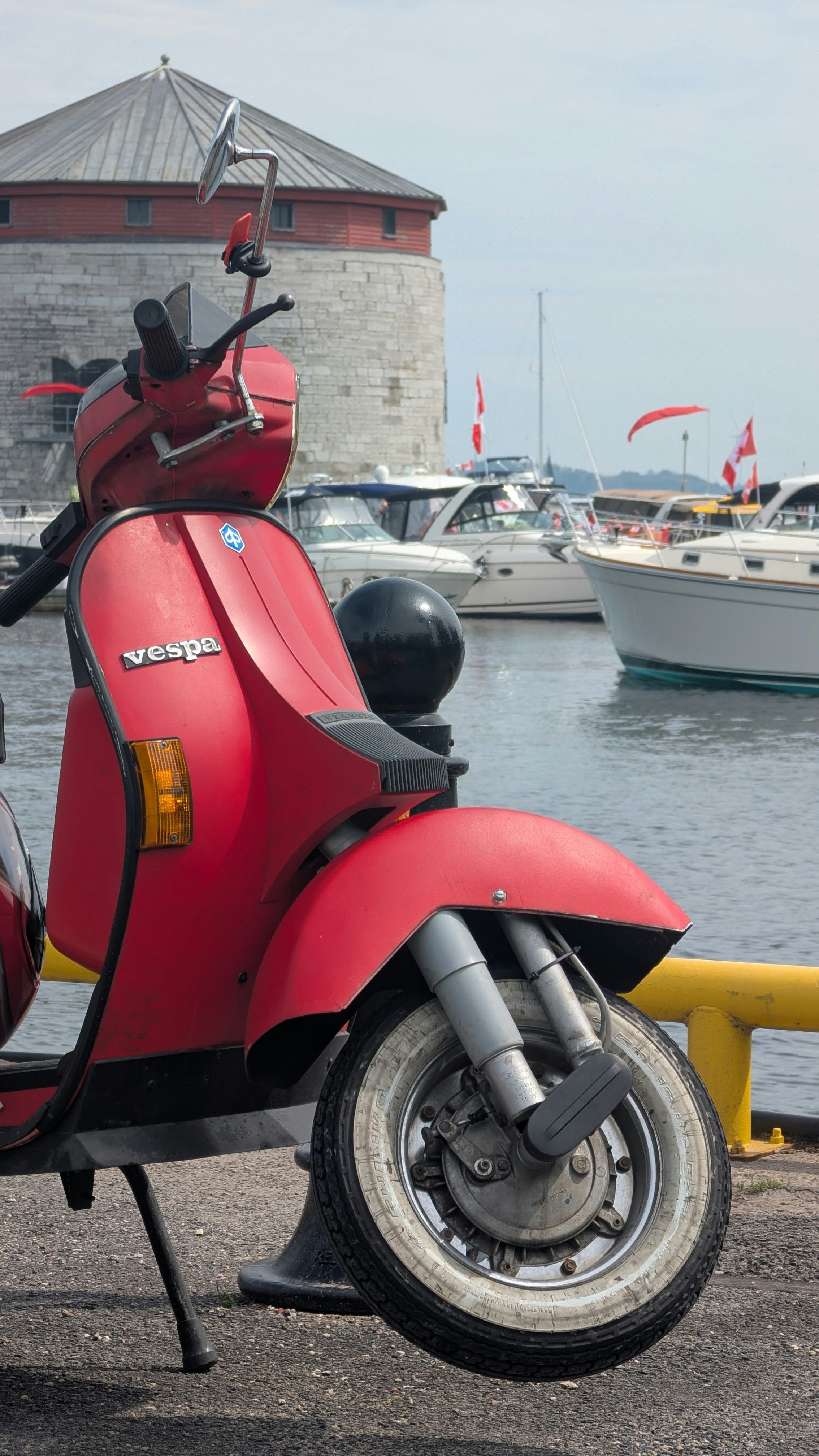 Crimson Vespa by the Marina: A Harbor Portrait of Color and Craft