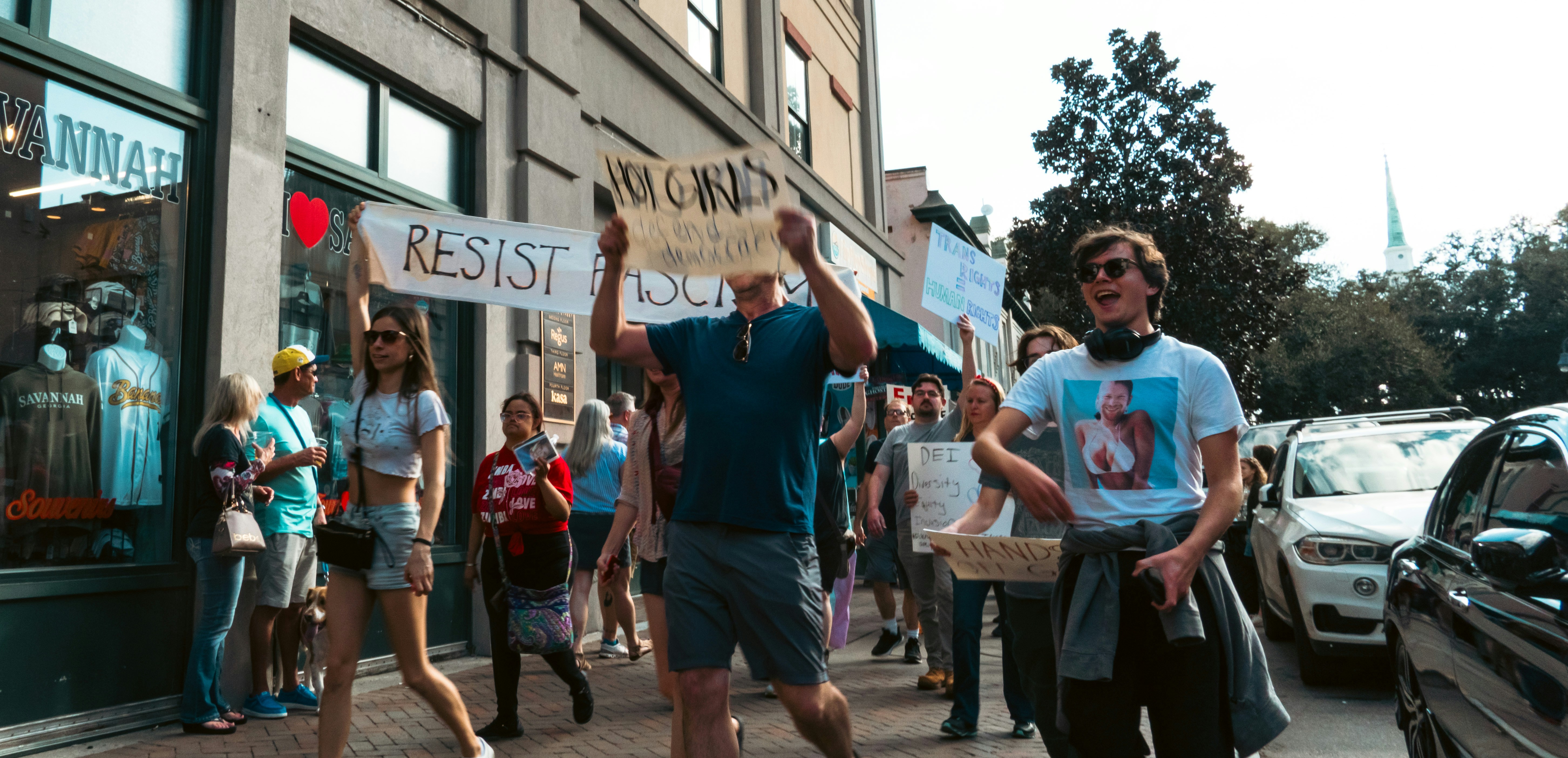 People are protesting with signs in the street.