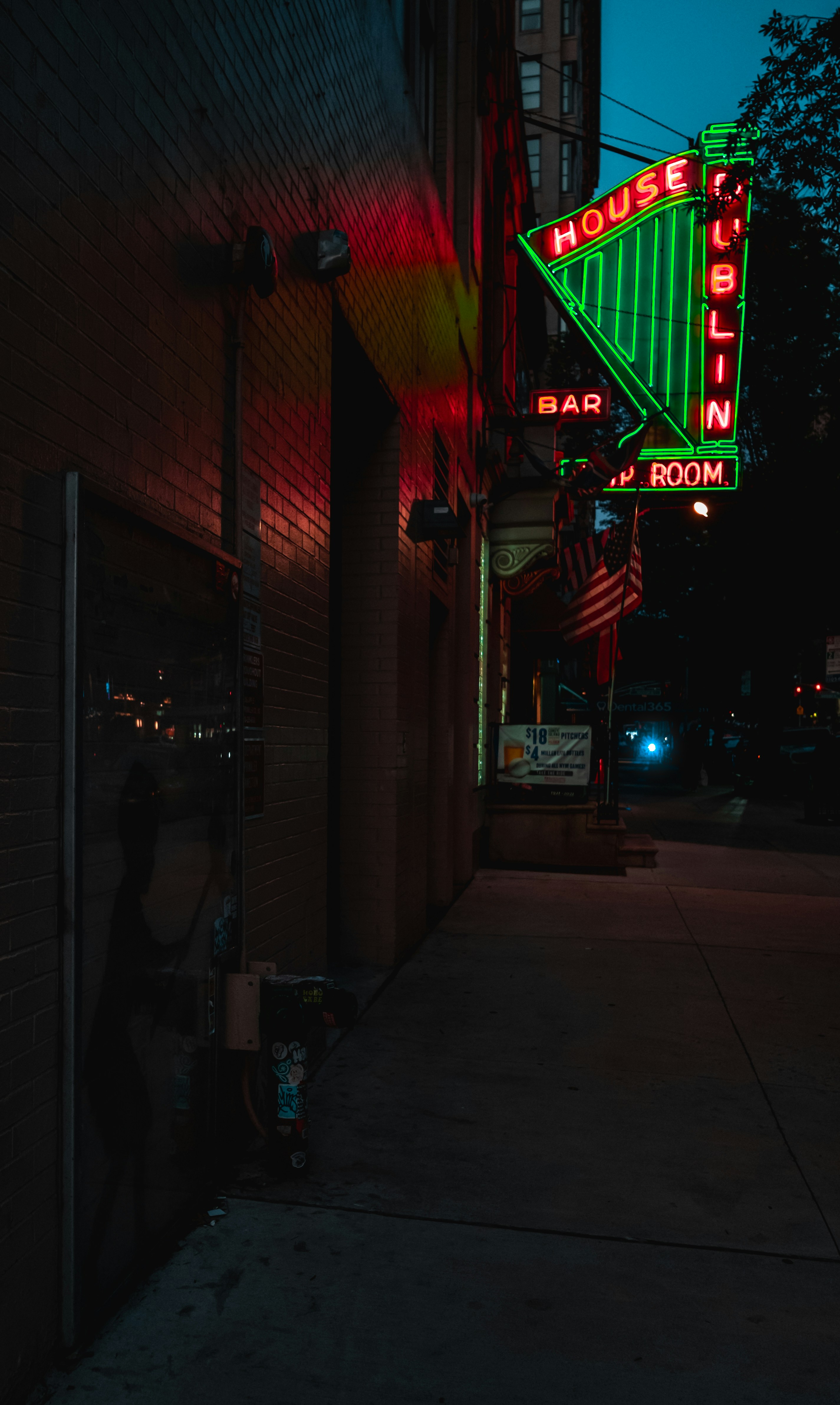 The neon sign of house of dublin glows at night.
