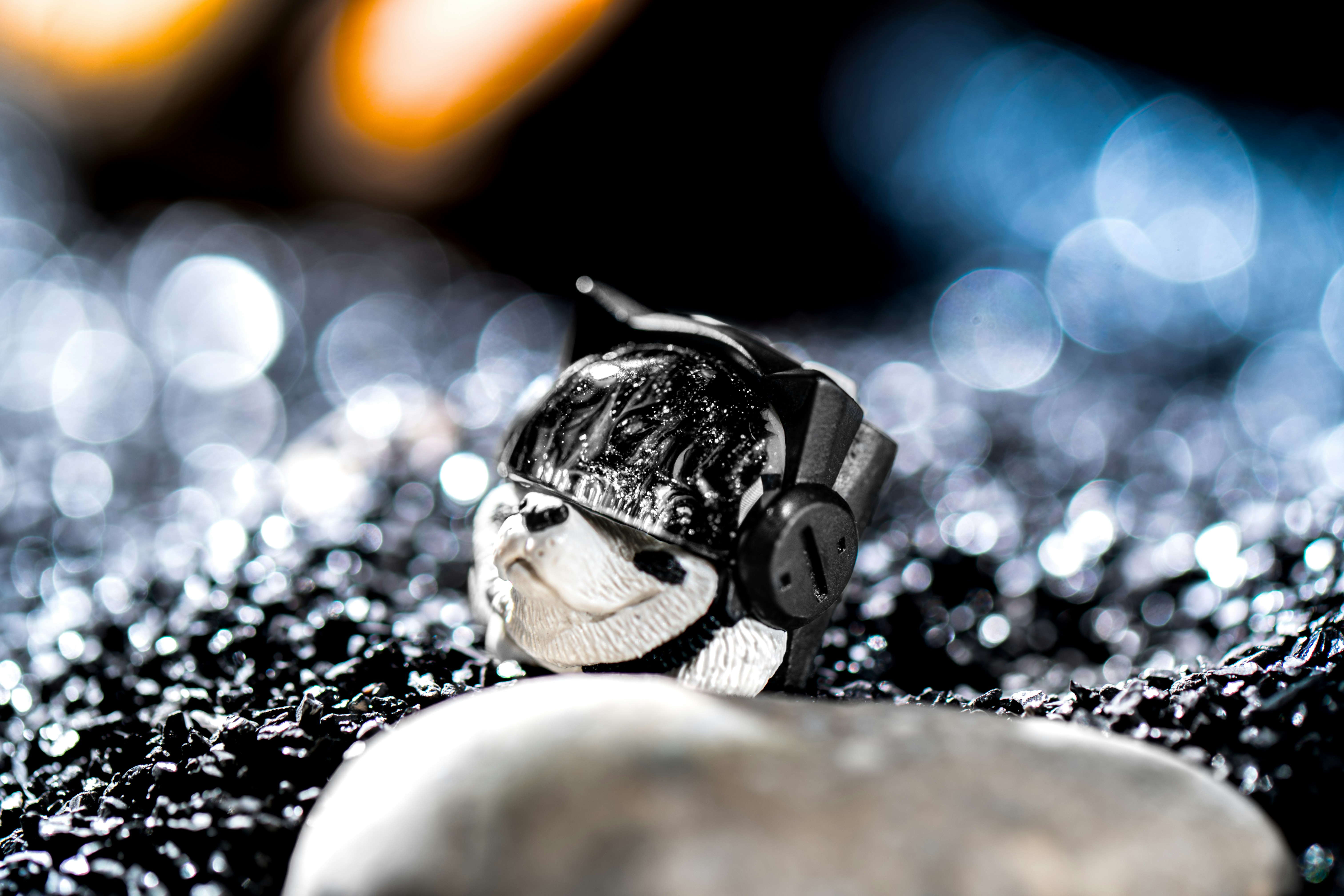 Headphones-Wearing Miniature Explorer on a Pebble-Strewn Stage