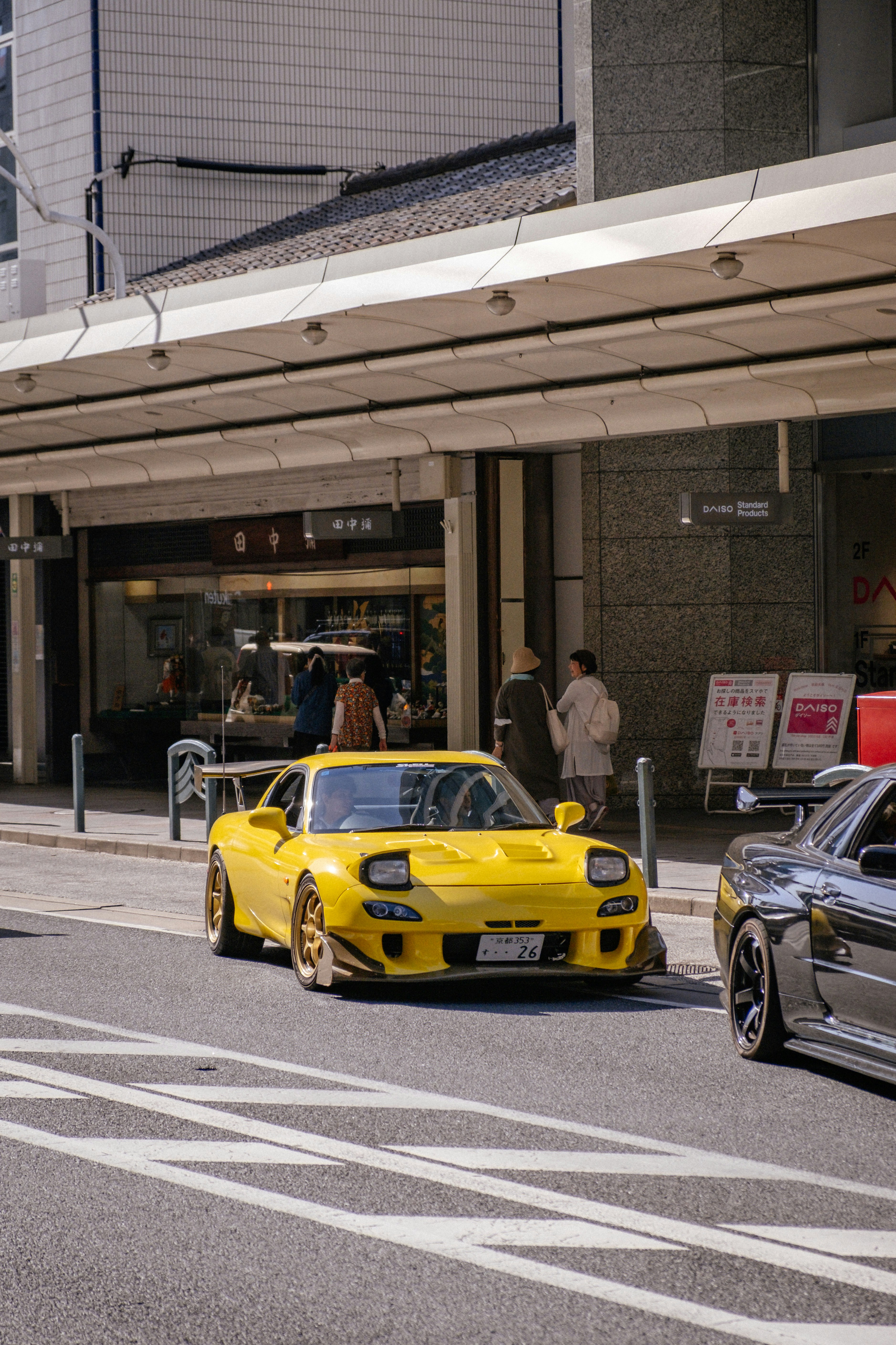 A bright yellow sports car is parked on a street.