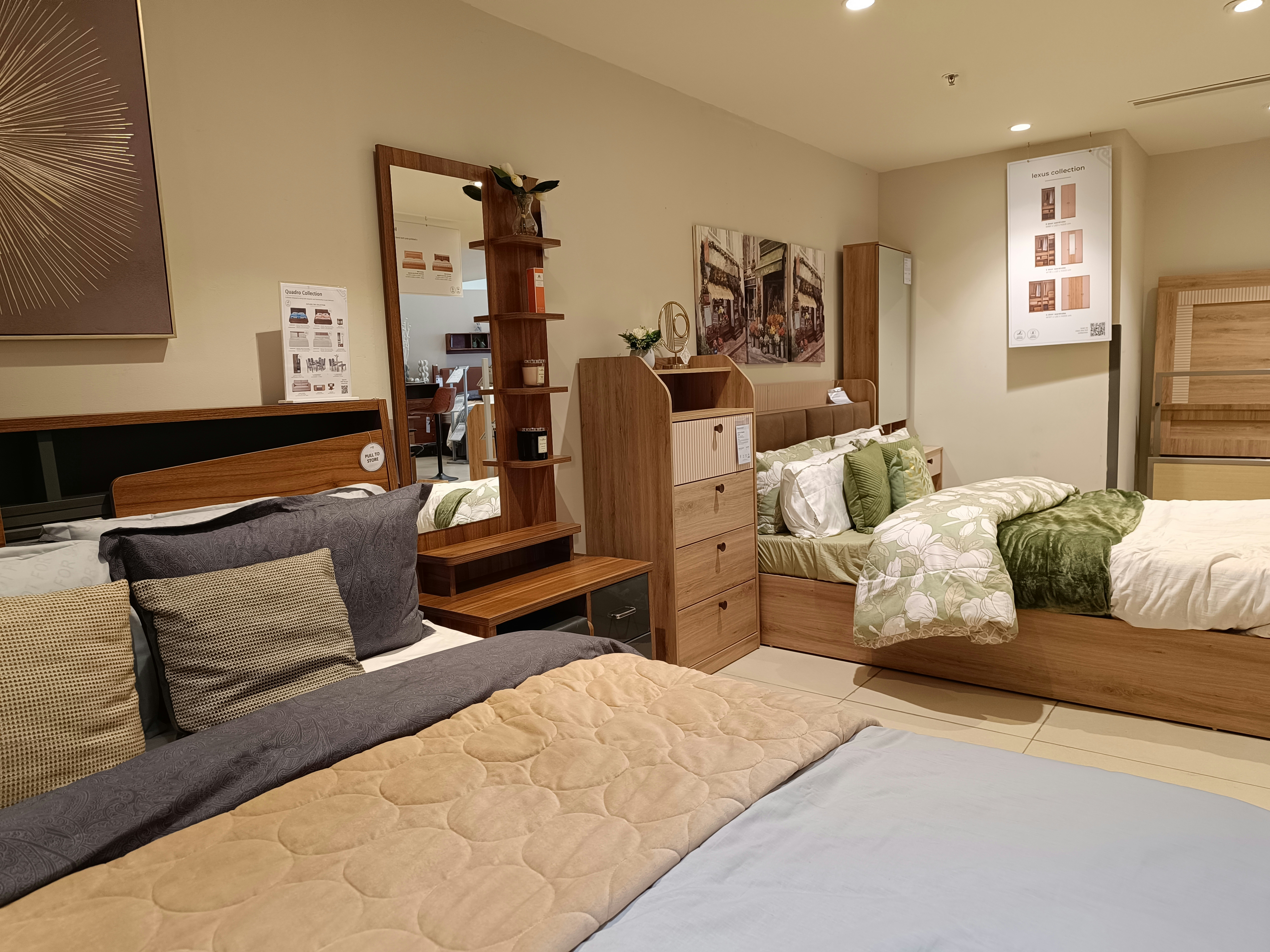 Bedroom furniture sets are displayed in a store.