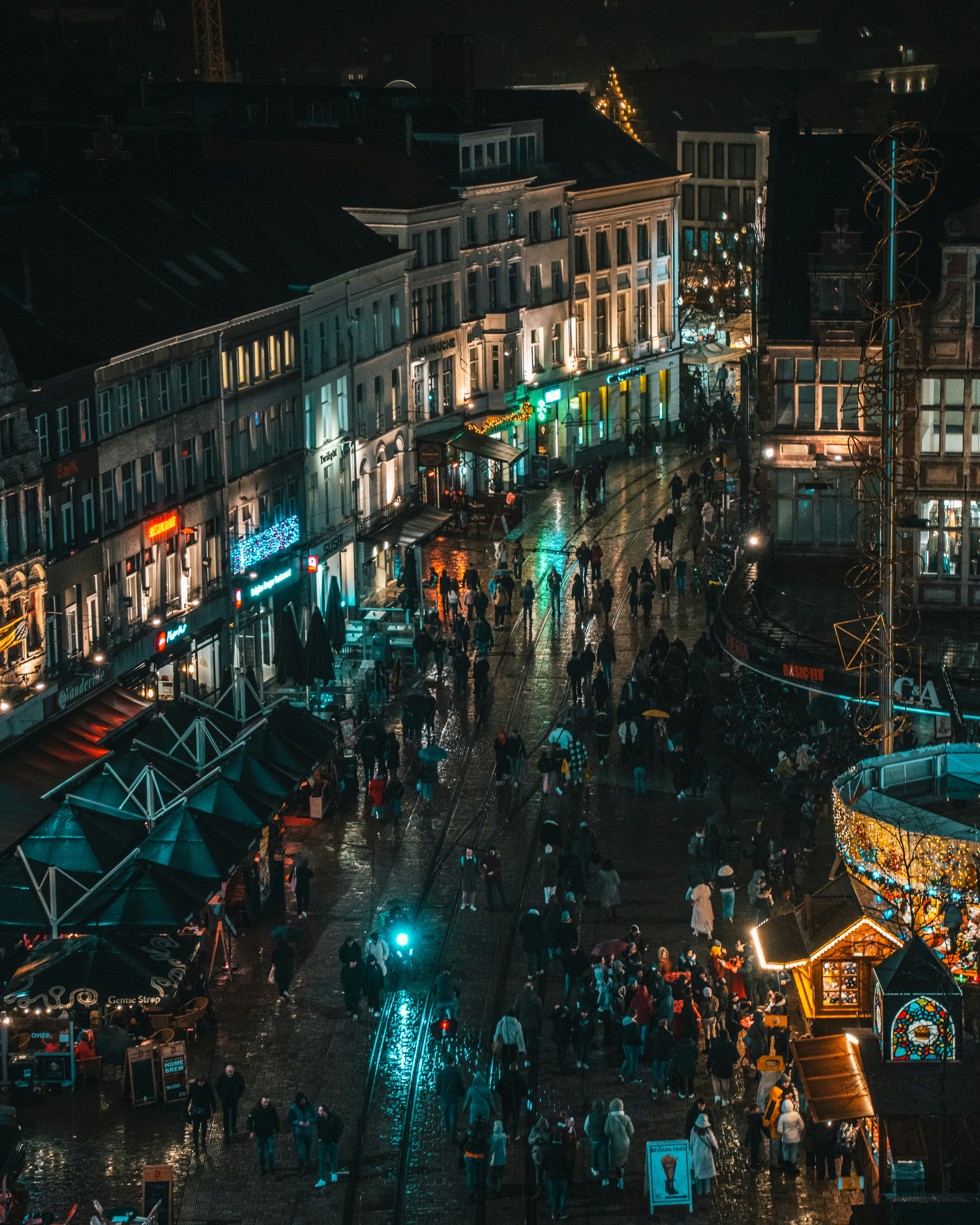 christmas night life in Gent Belgium | A bustling city street is alive at night.
