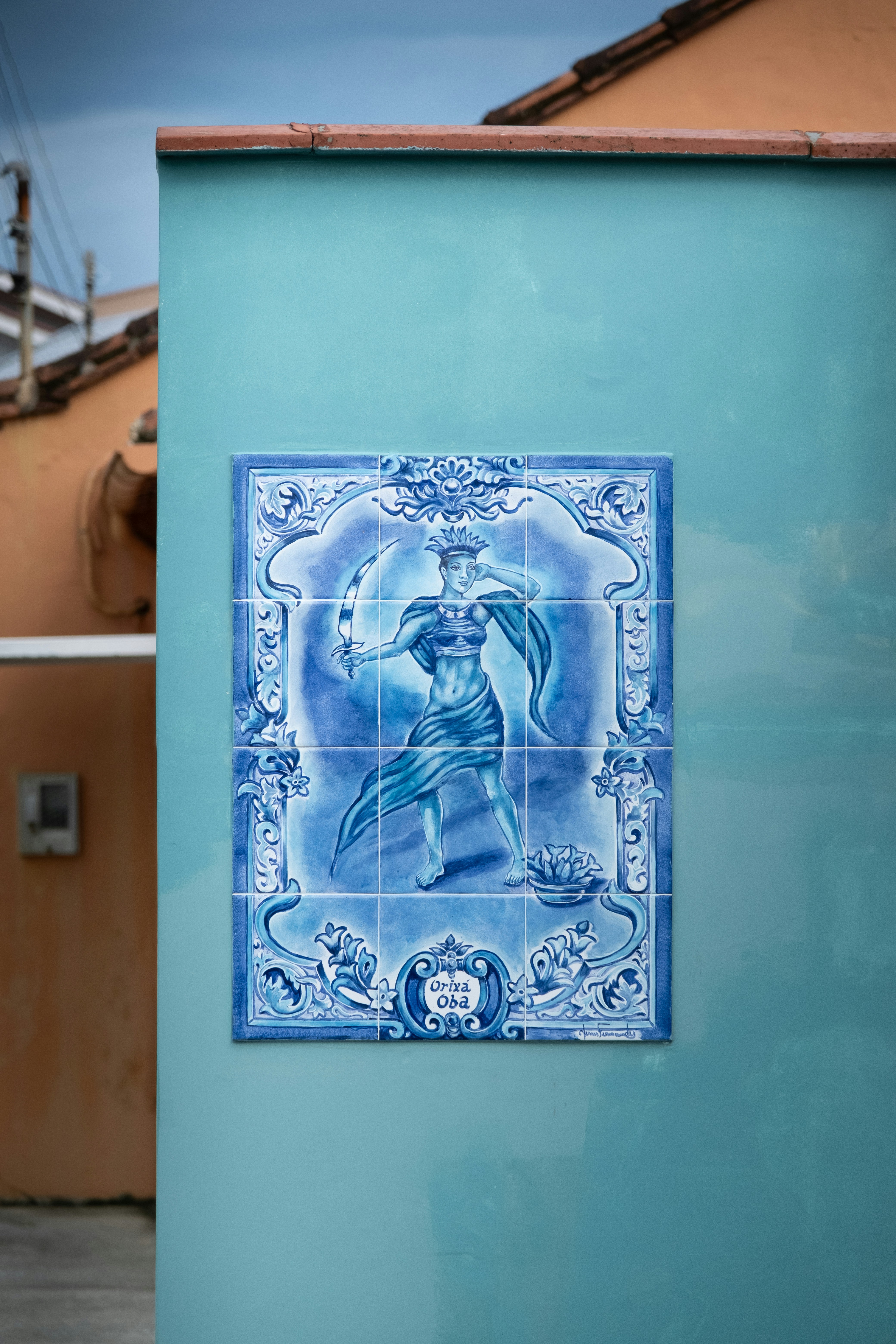 Delft-Blue Dancer on a Turquoise Facade
