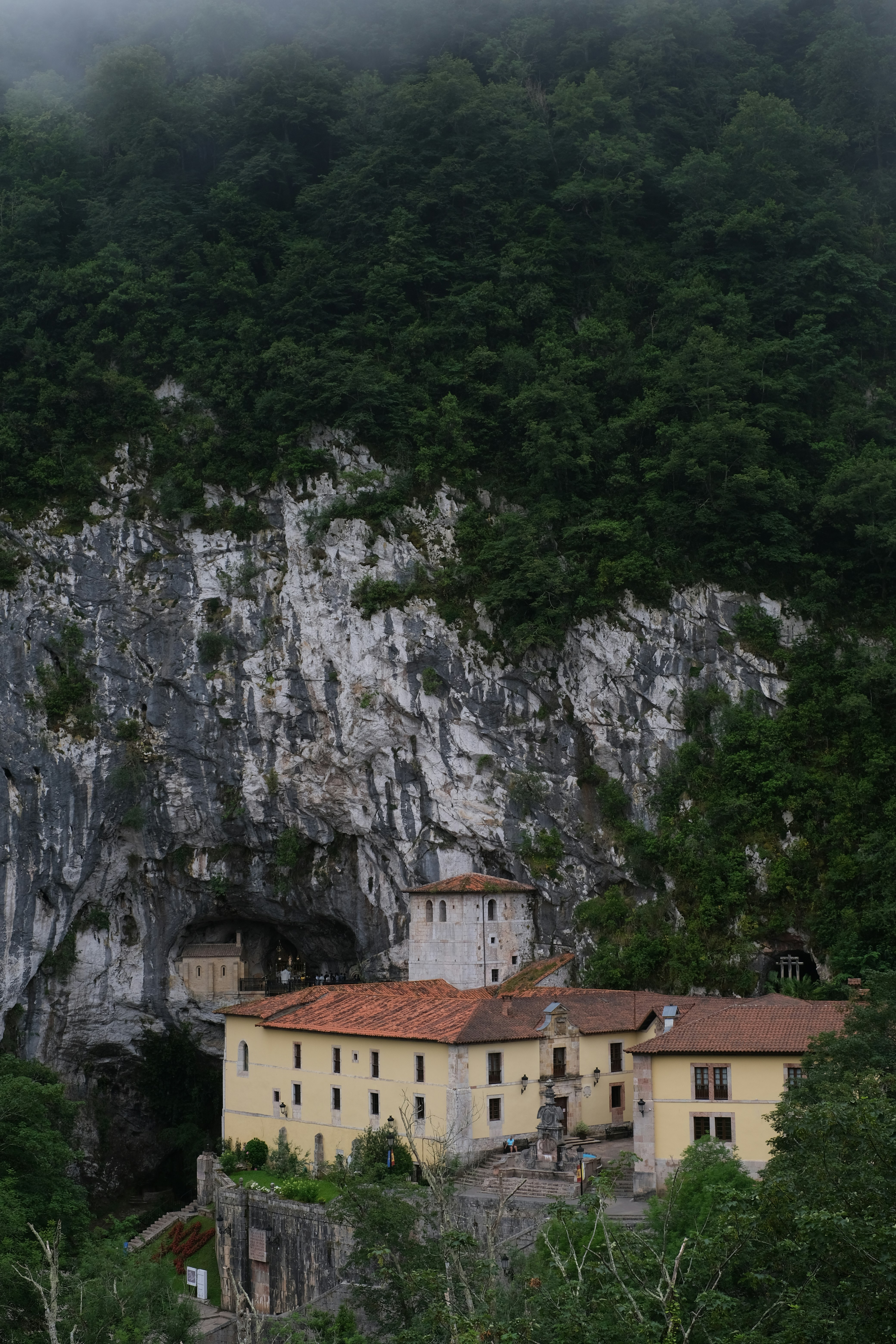 A monastery is built into a cliffside.