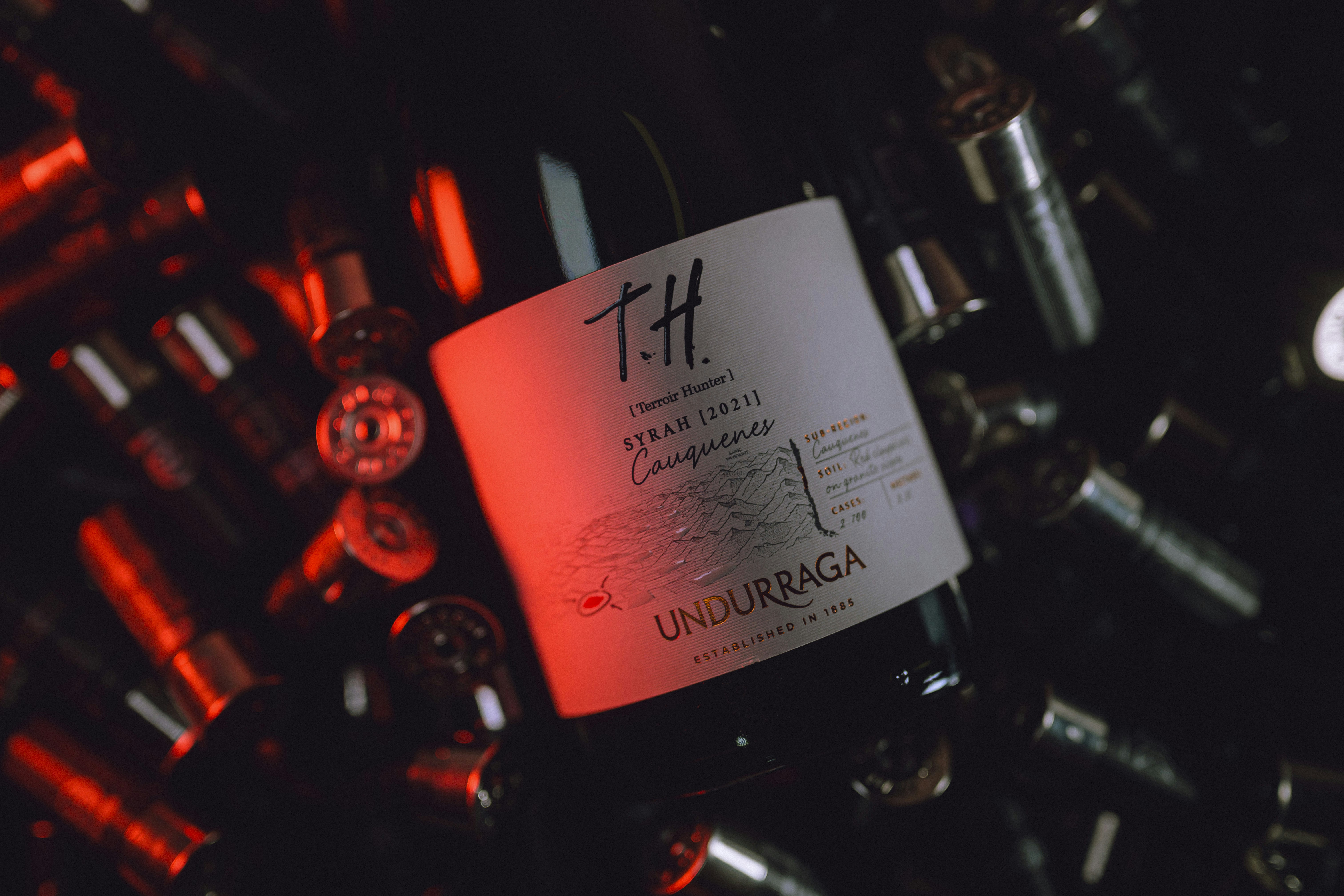 Crimson Glow on a Central Wine Label in a Dim Cellar