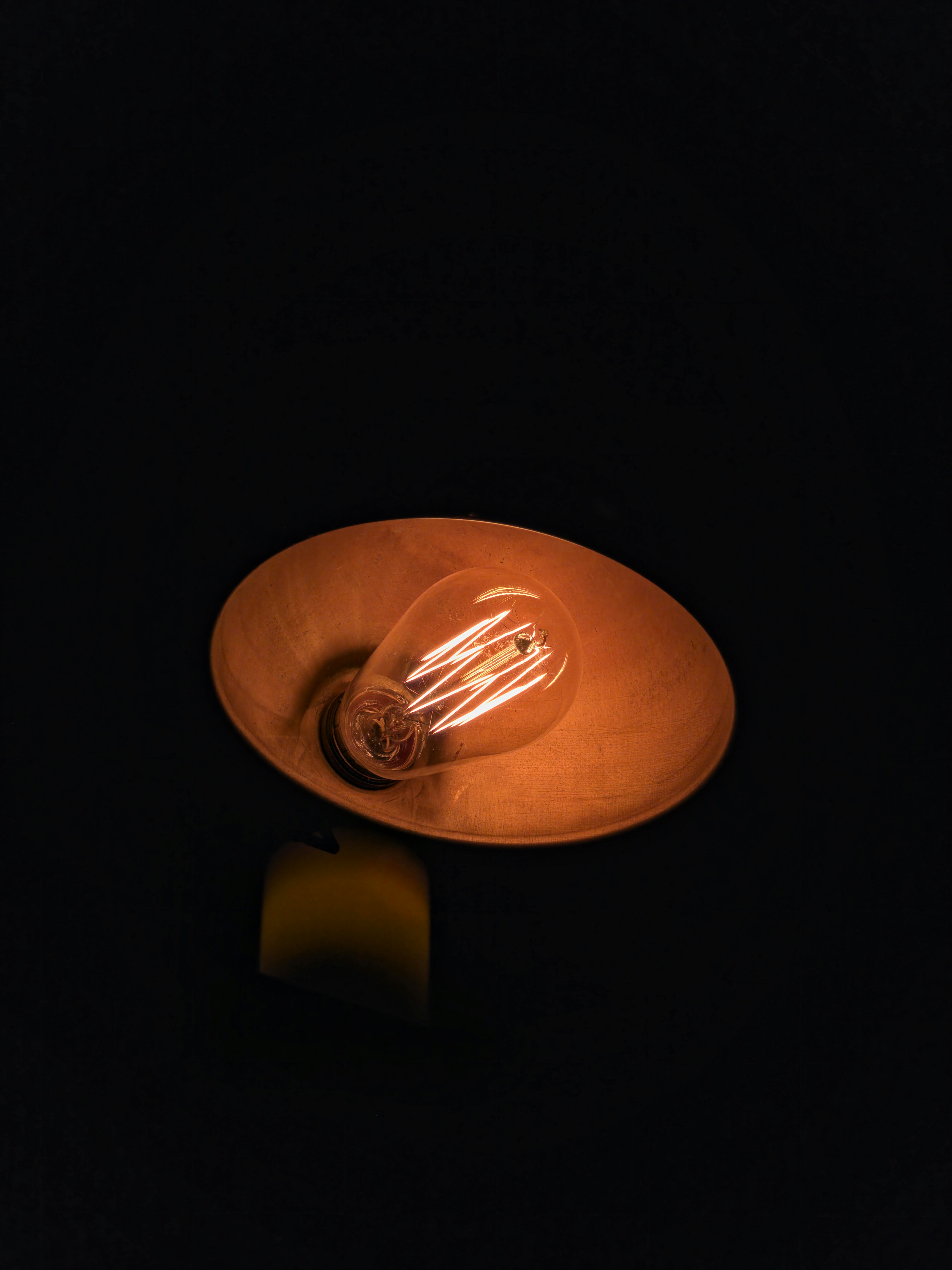 Let there be light! | A lit light bulb casts a warm glow.