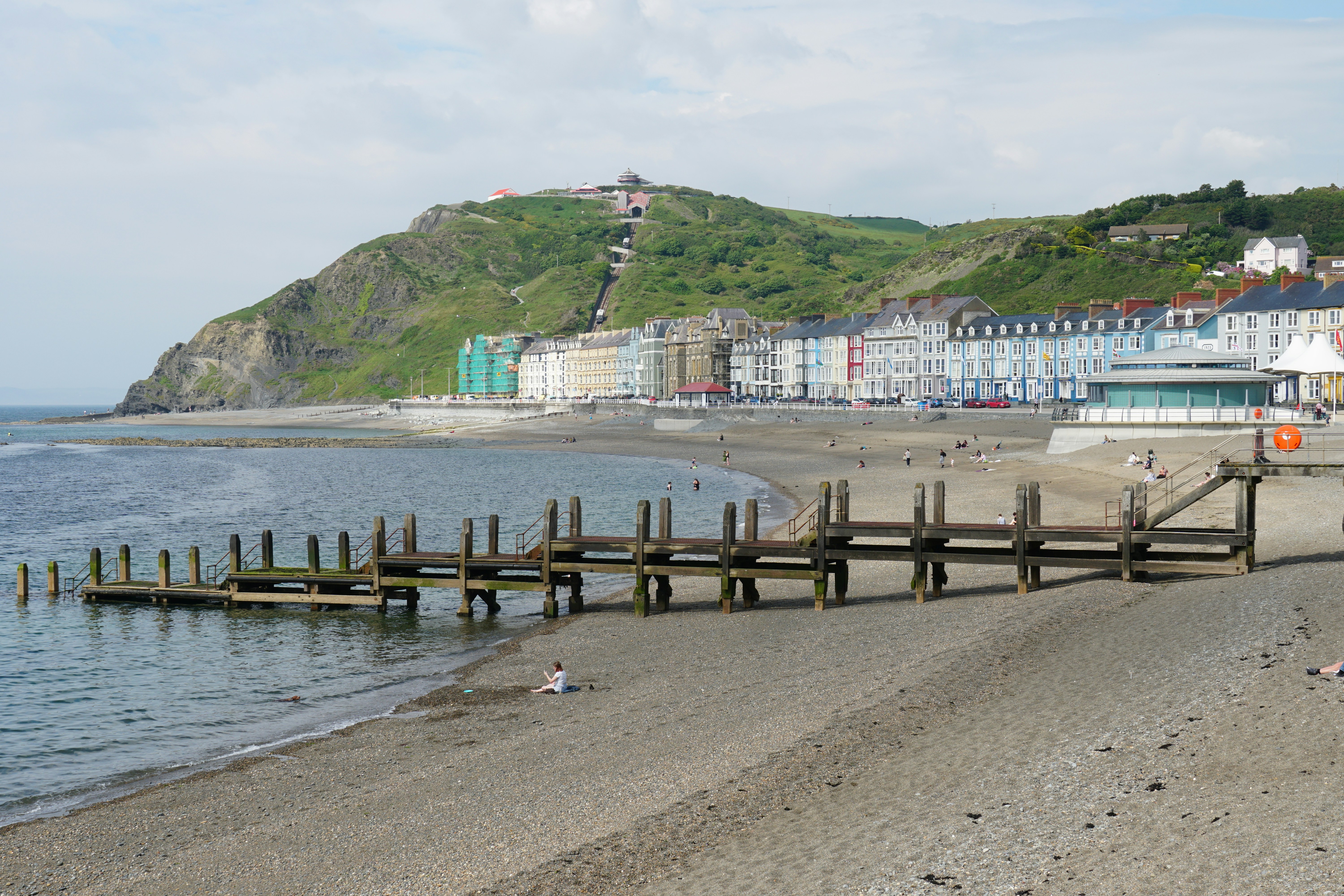 A seaside view with beach and town in distance.