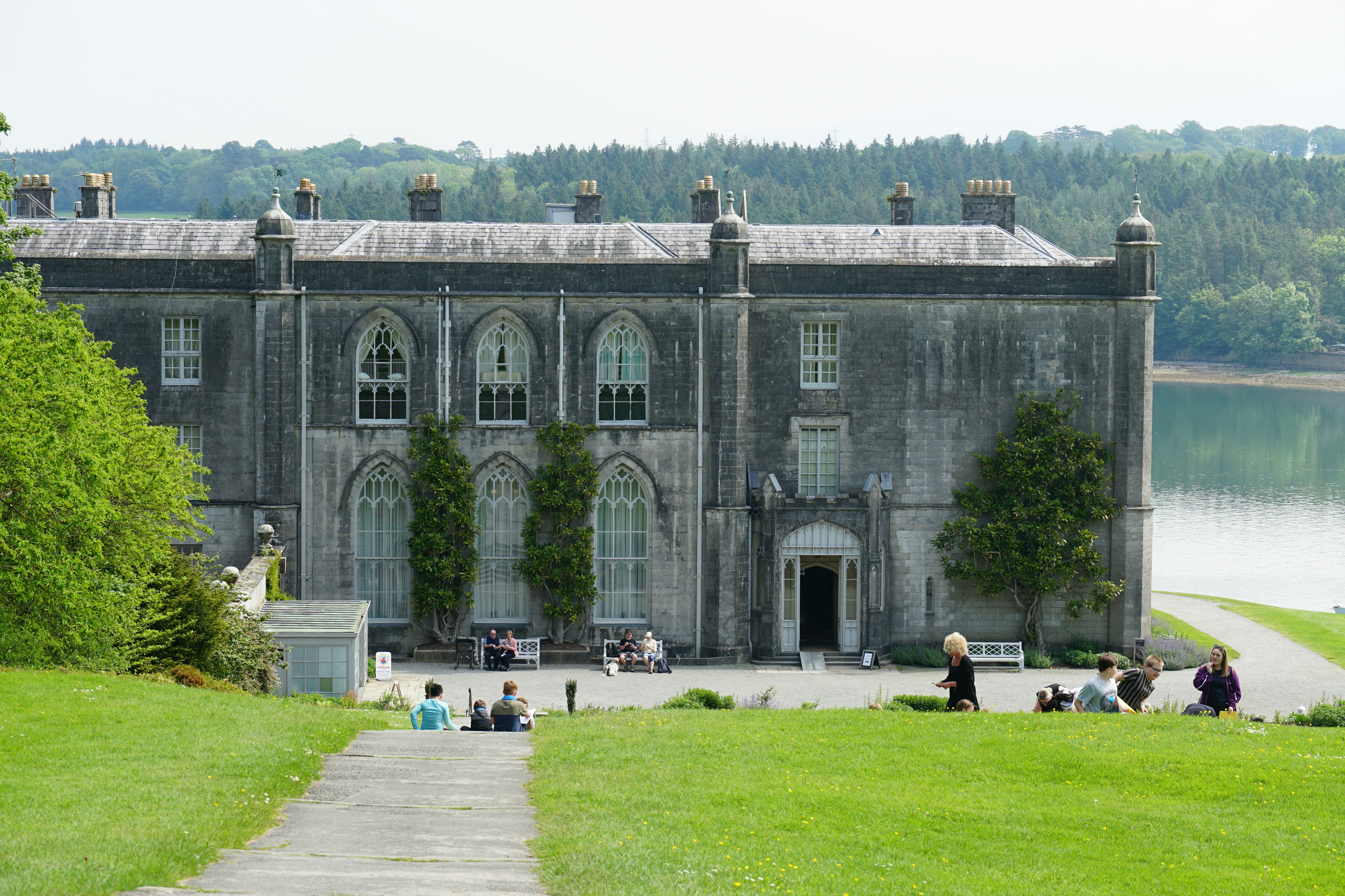 A grand old house is situated by the water.