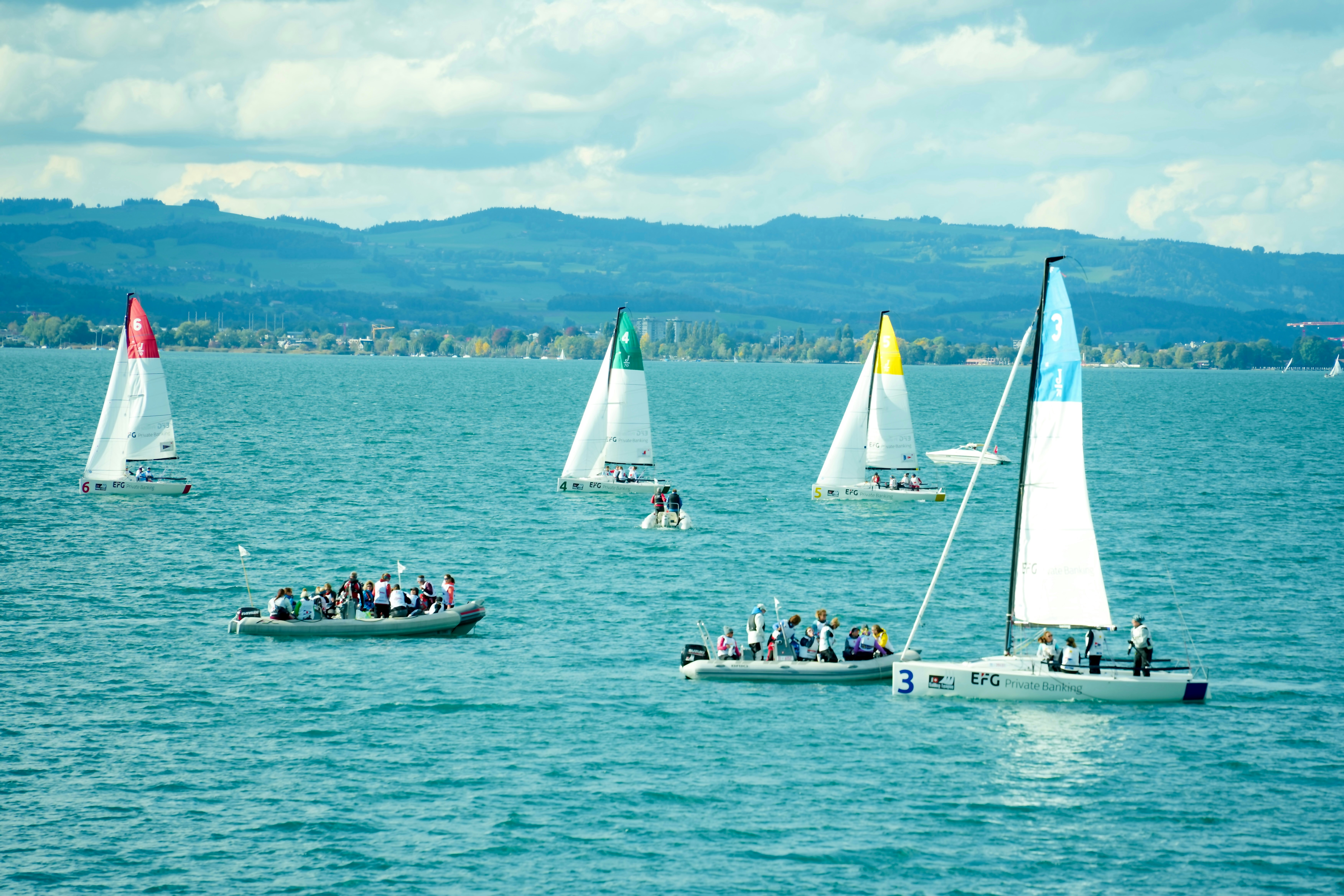 Sailboats and boats are sailing on the water.