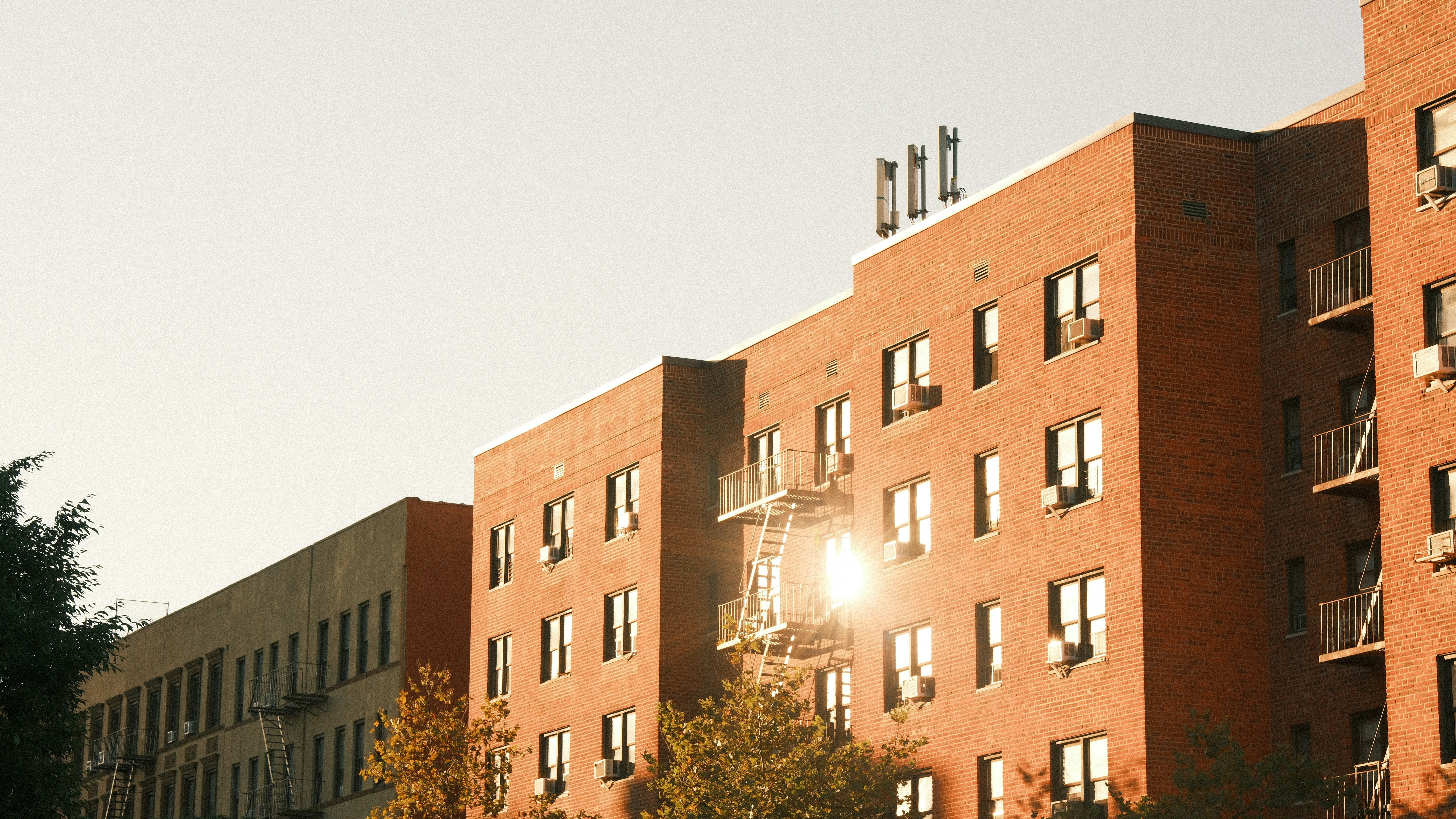 A brick building is illuminated by the sun.