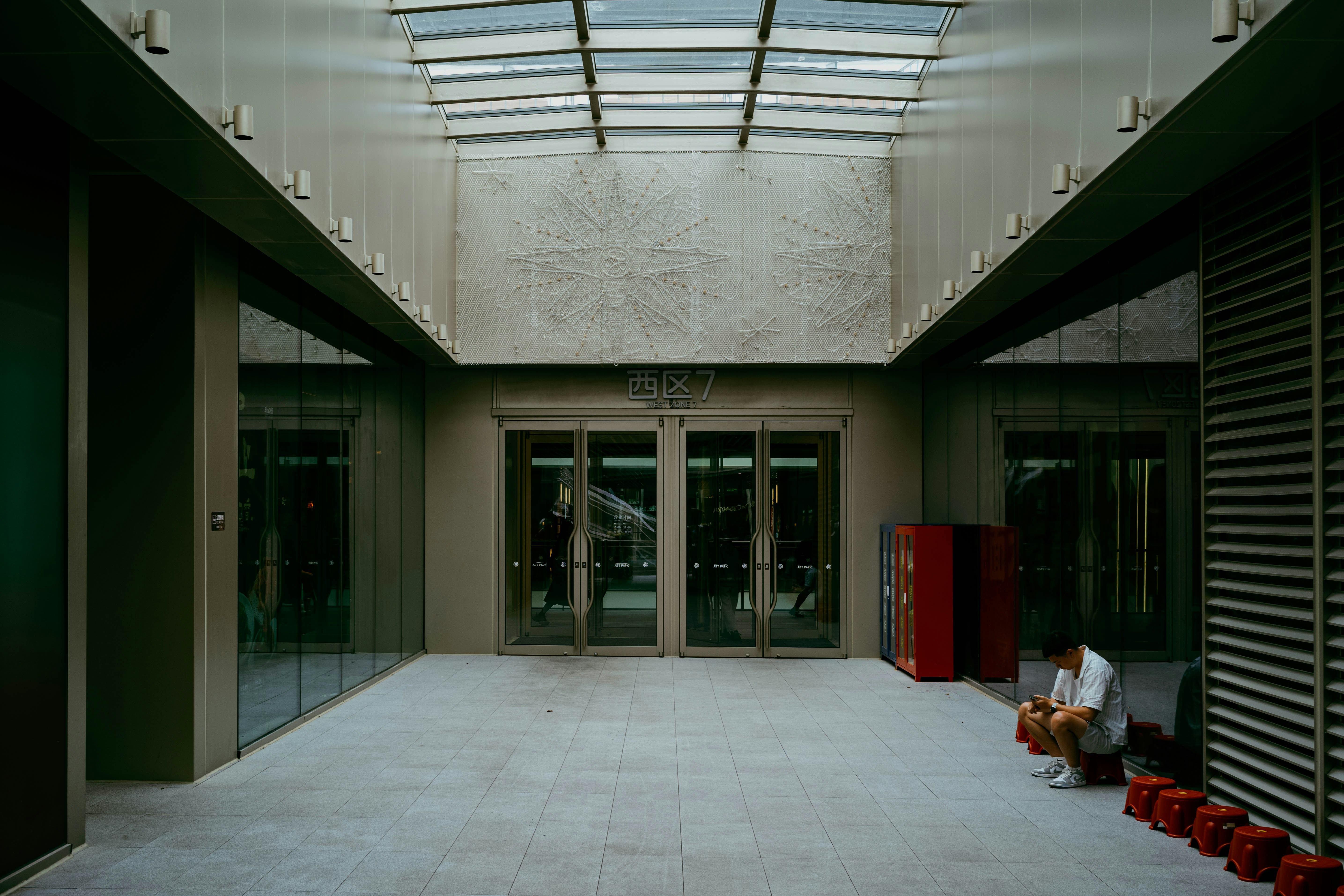 A bright, modern building interior with glass doors.