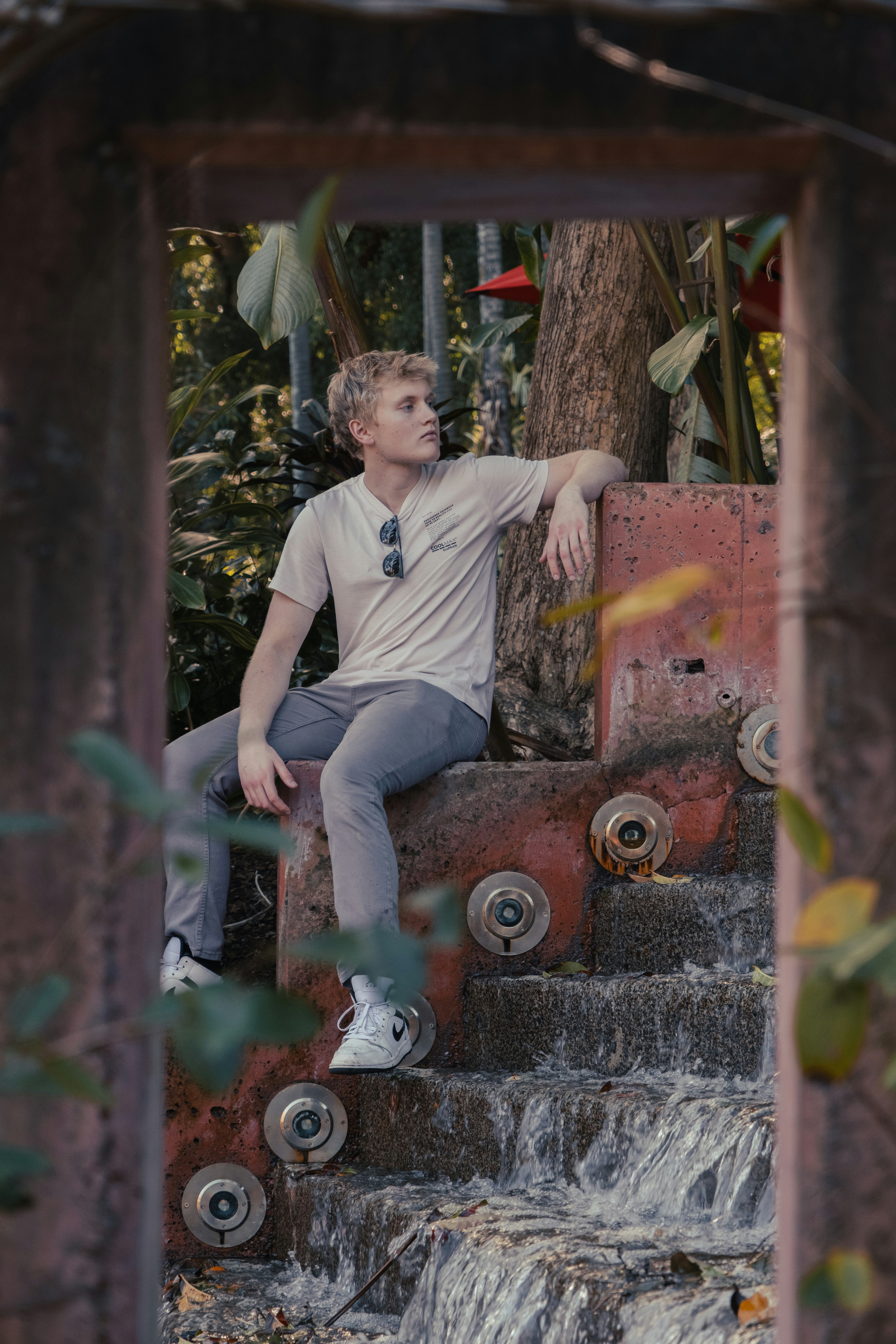 A man poses on an outdoor staircase.