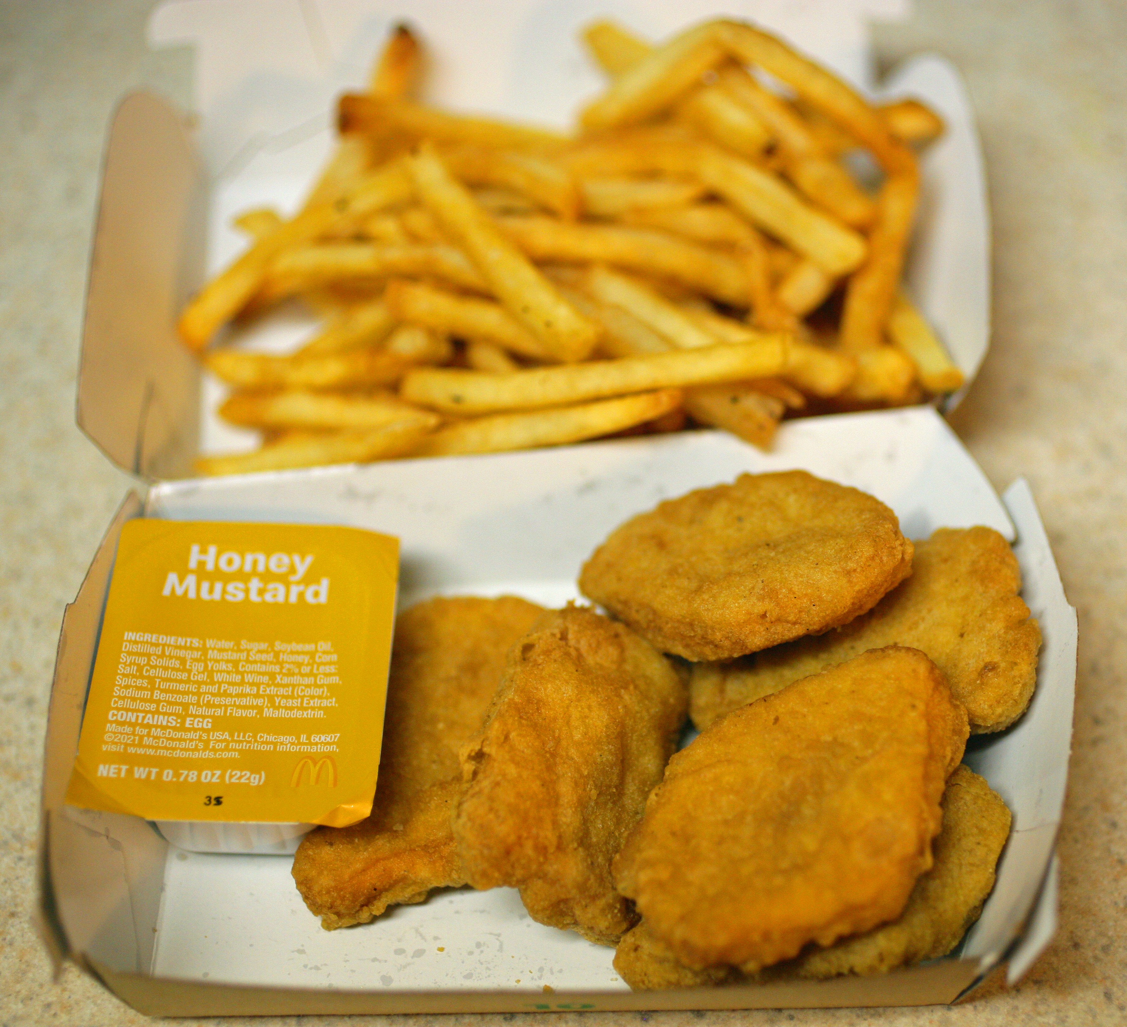 Mcdonald's chicken nuggets with fries.