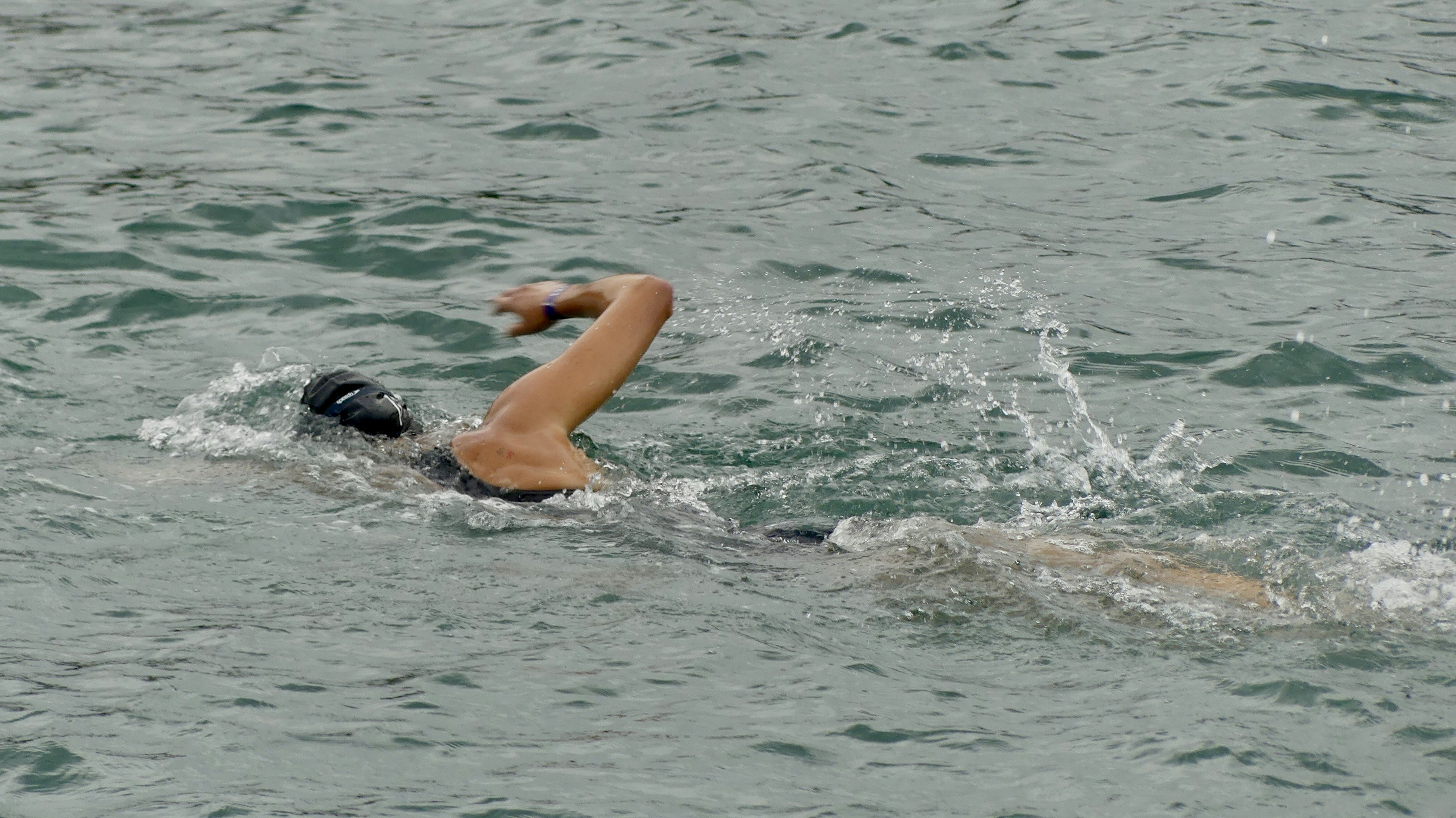A swimmer exercises in a body of water. photo – Free Woman Image on ...