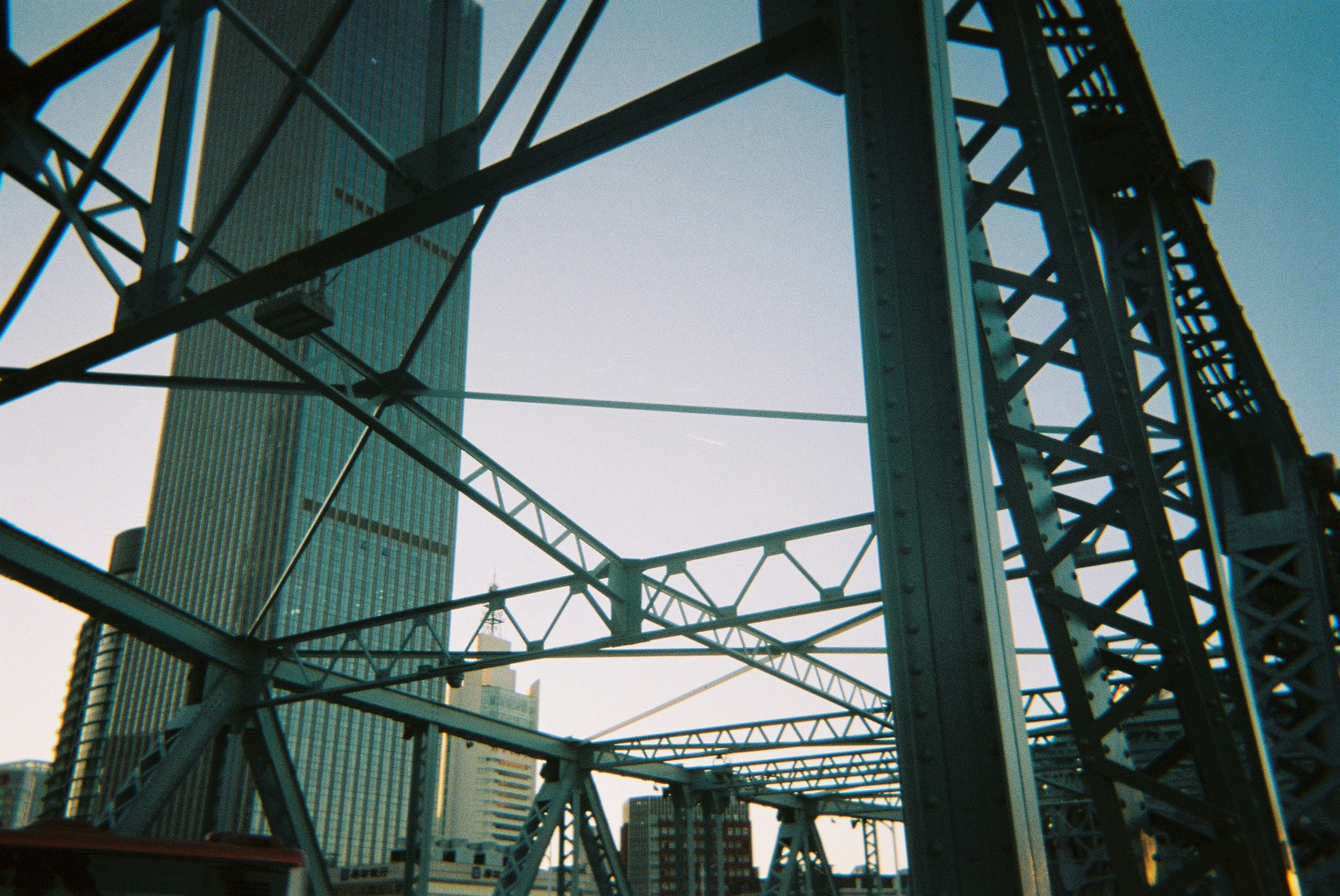 Steel bridge frames a modern skyscraper.