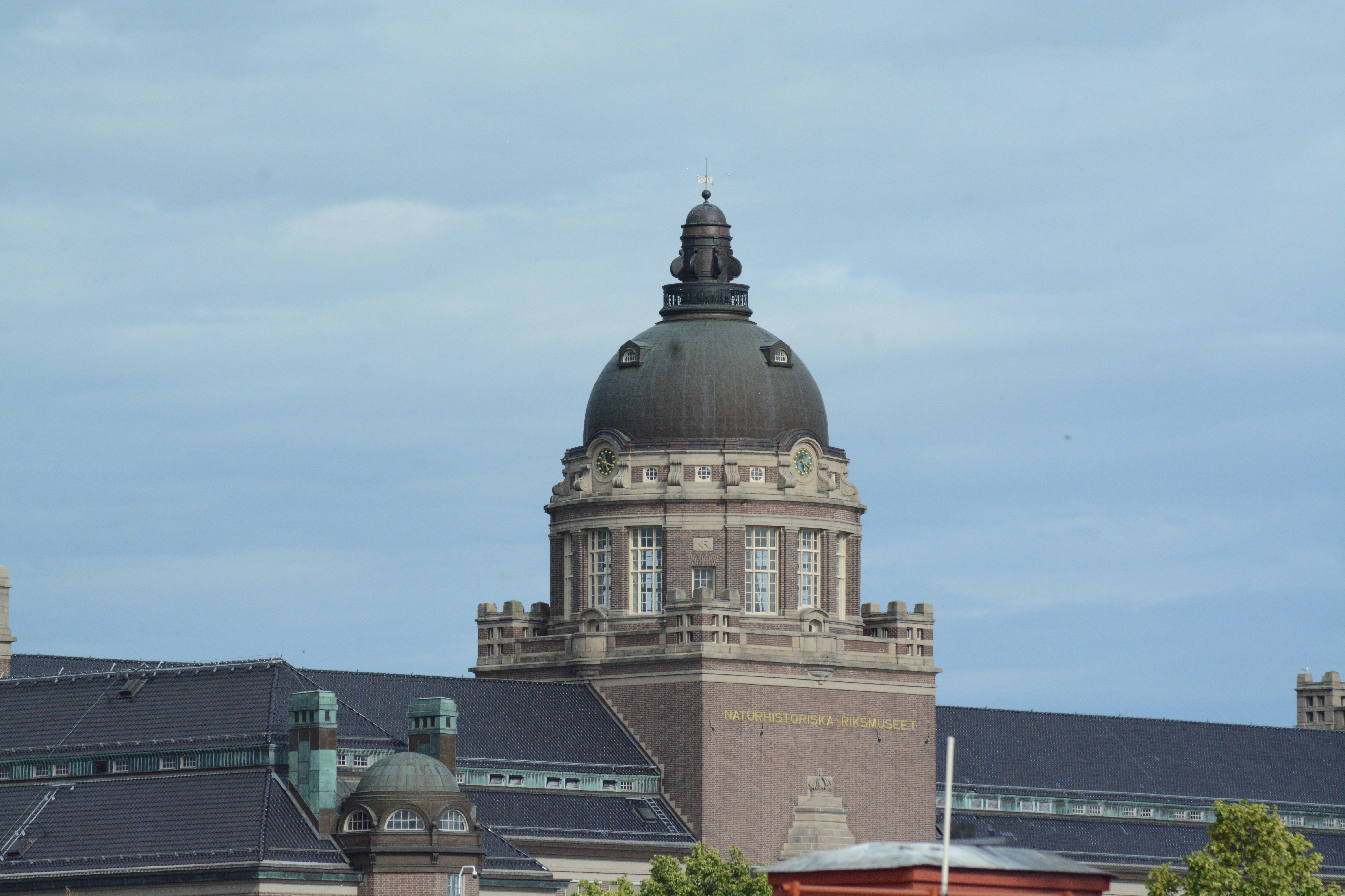 Historic building featuring a prominent dome, showcasing intricate architectural details against a serene sky.