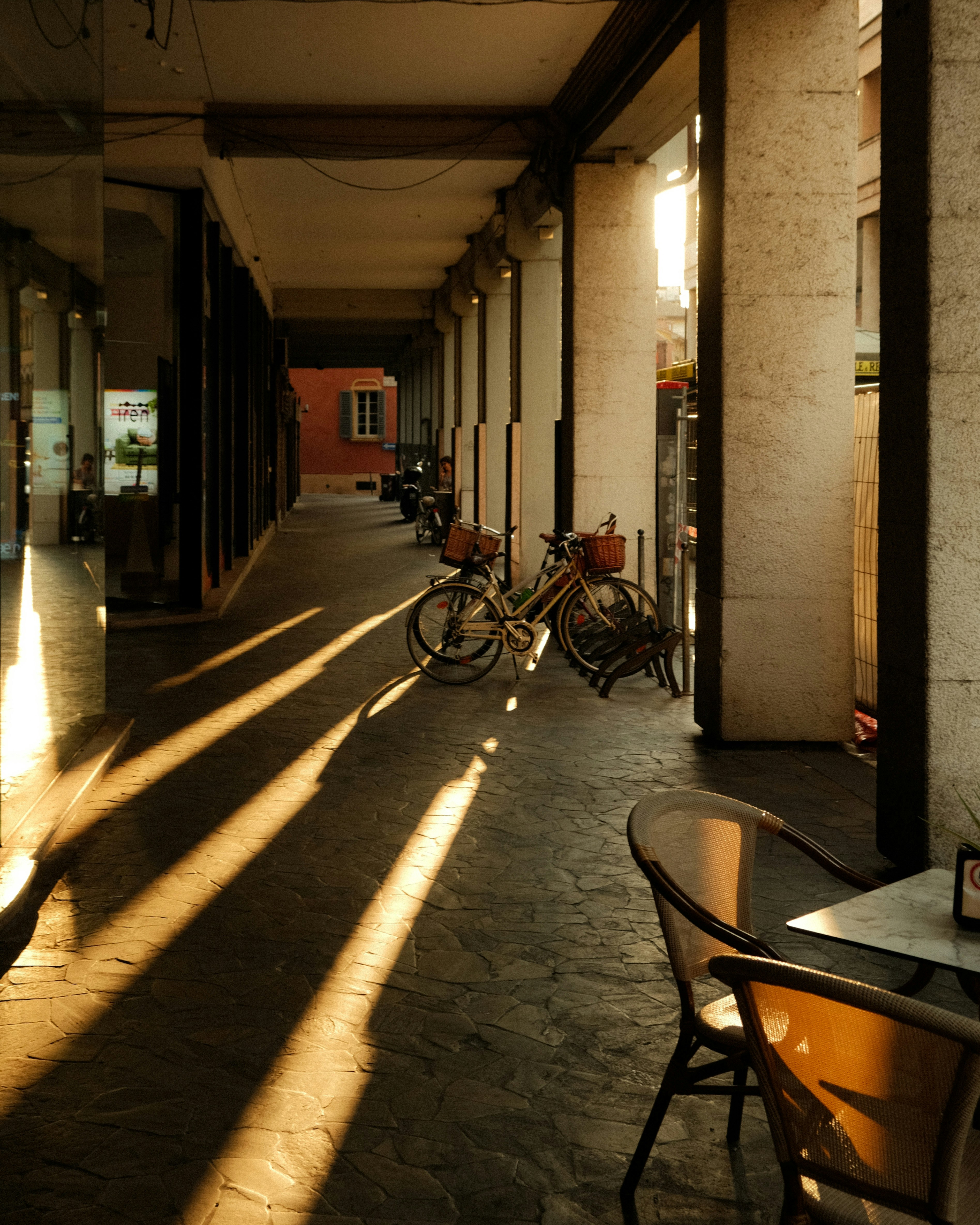 Sunlight streams through an arcade on a row of pillars. photo – Free ...