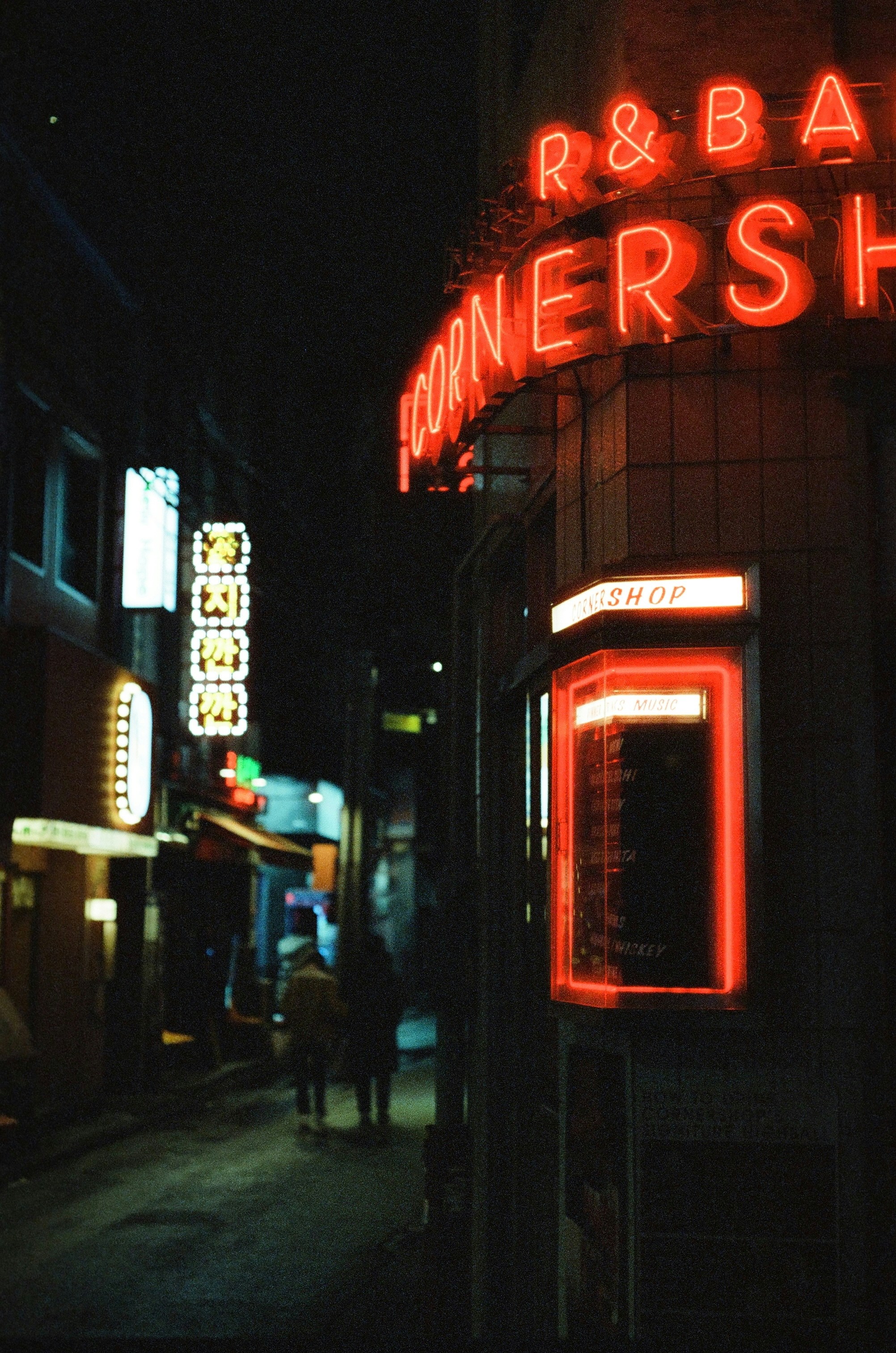 Neon signs illuminate a dimly lit street at night. photo – Free Street ...