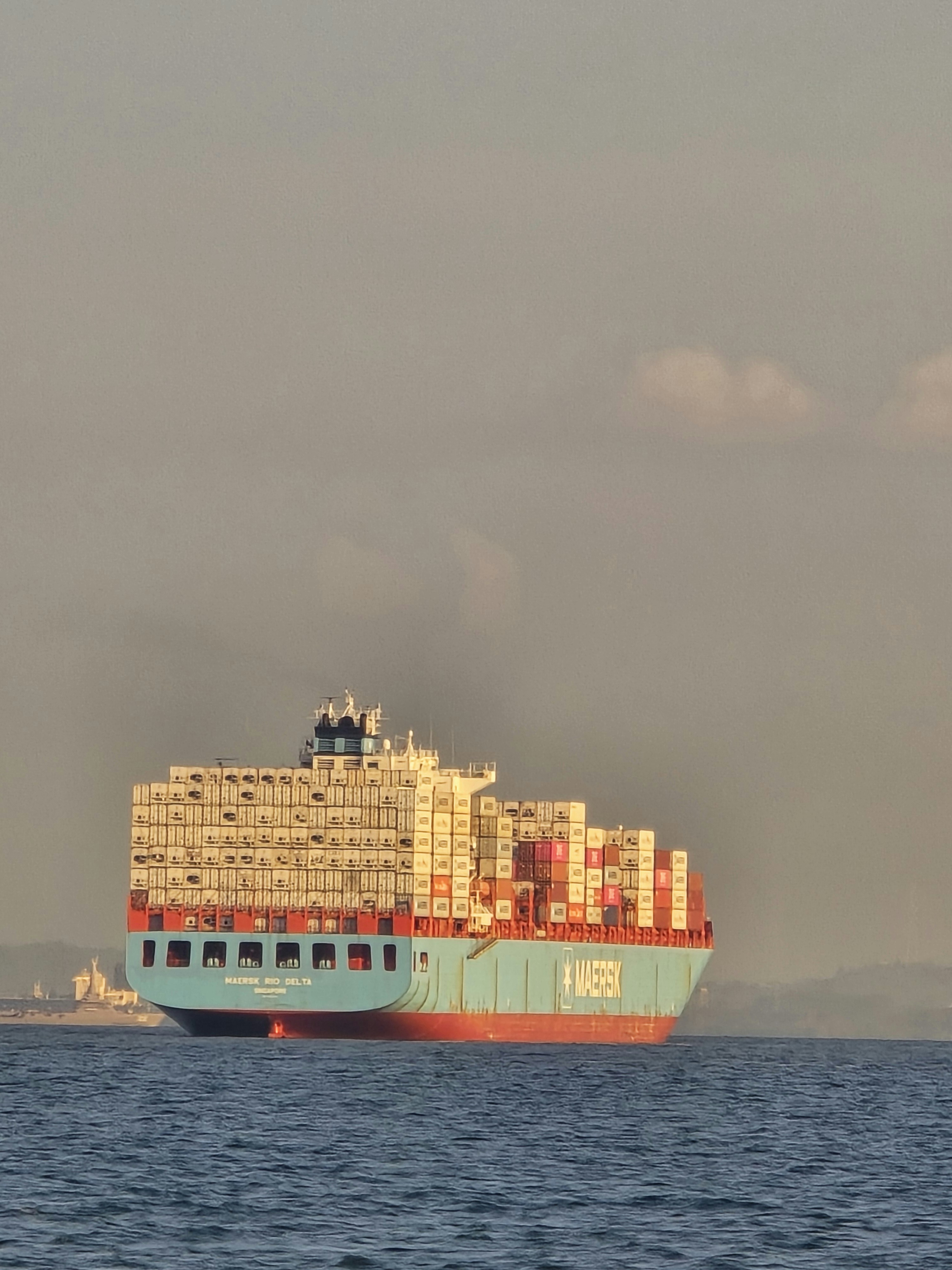 A large container ship sails on the ocean.