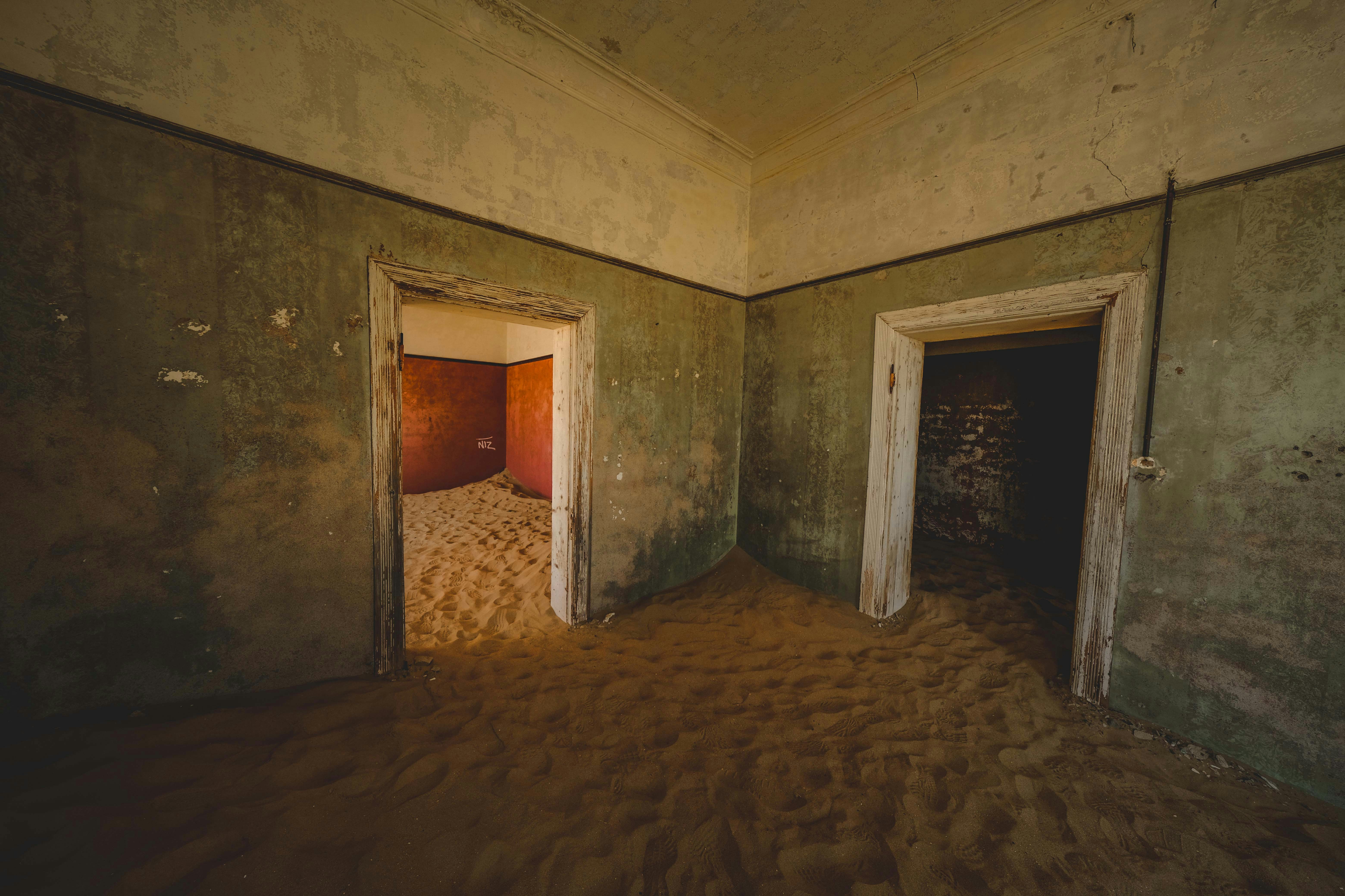 Sand fills an abandoned room with open doorways. photo – Free Namibia ...