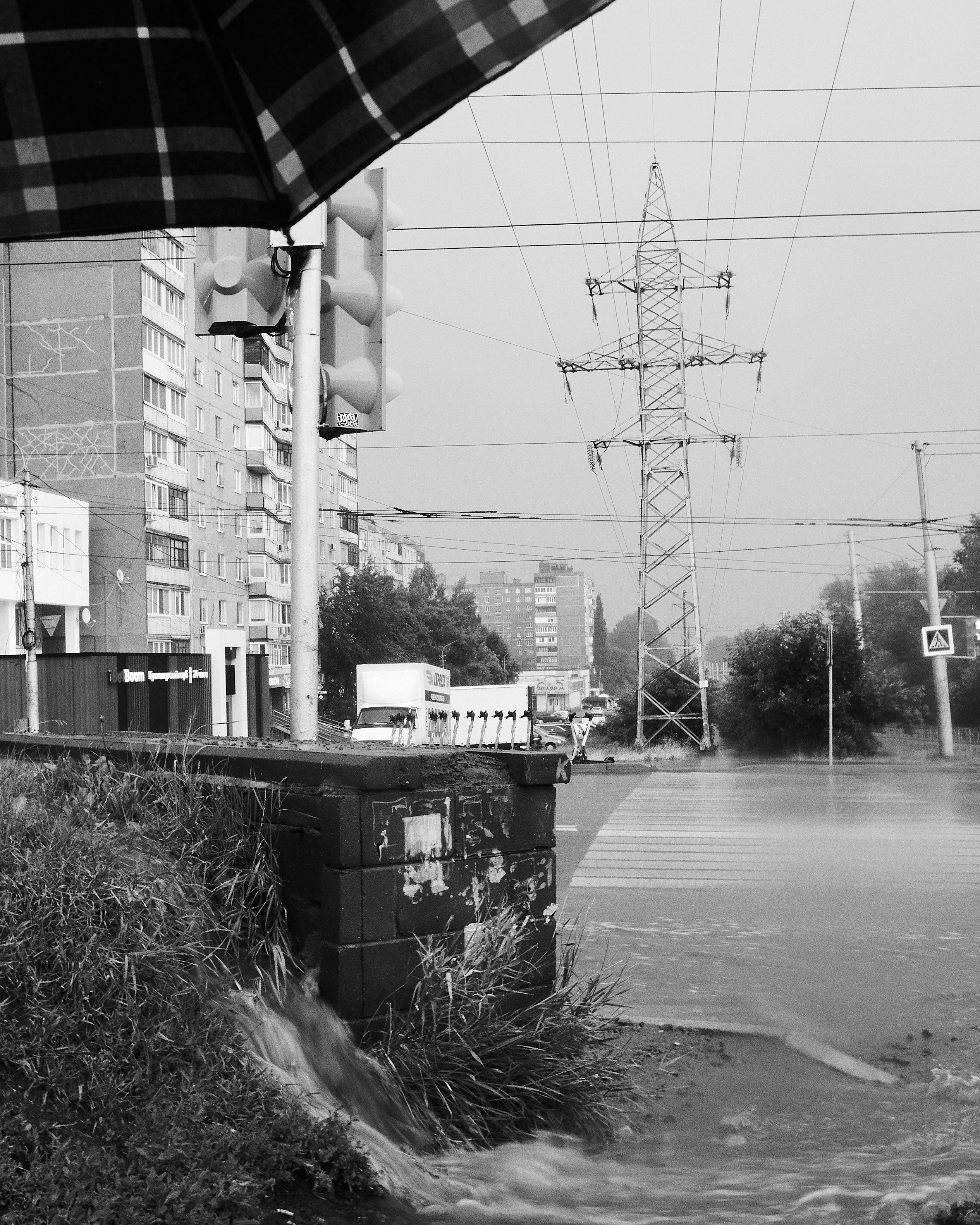 Flooding street scene from under an umbrella.