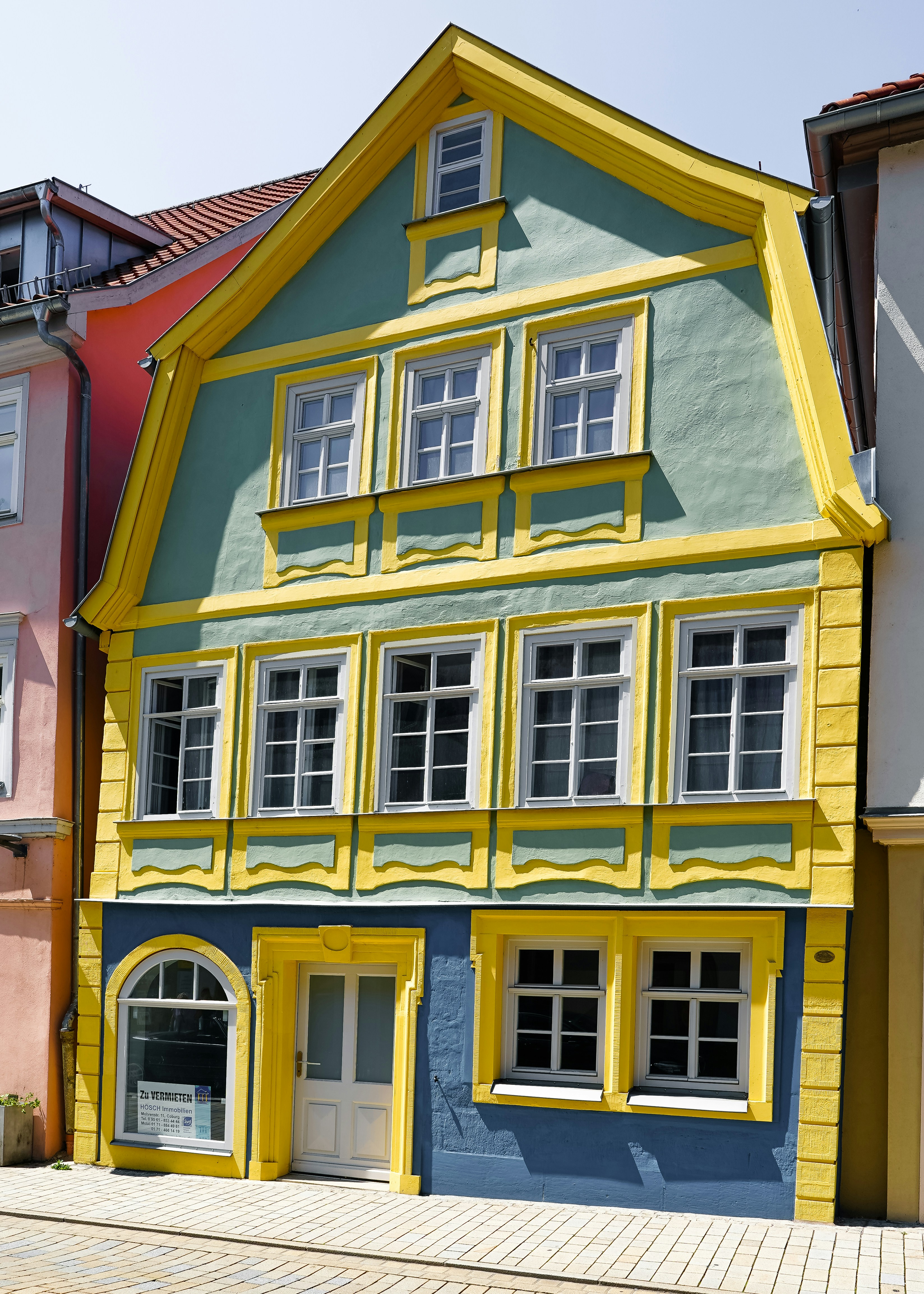 A colorful house with blue, green, and yellow.