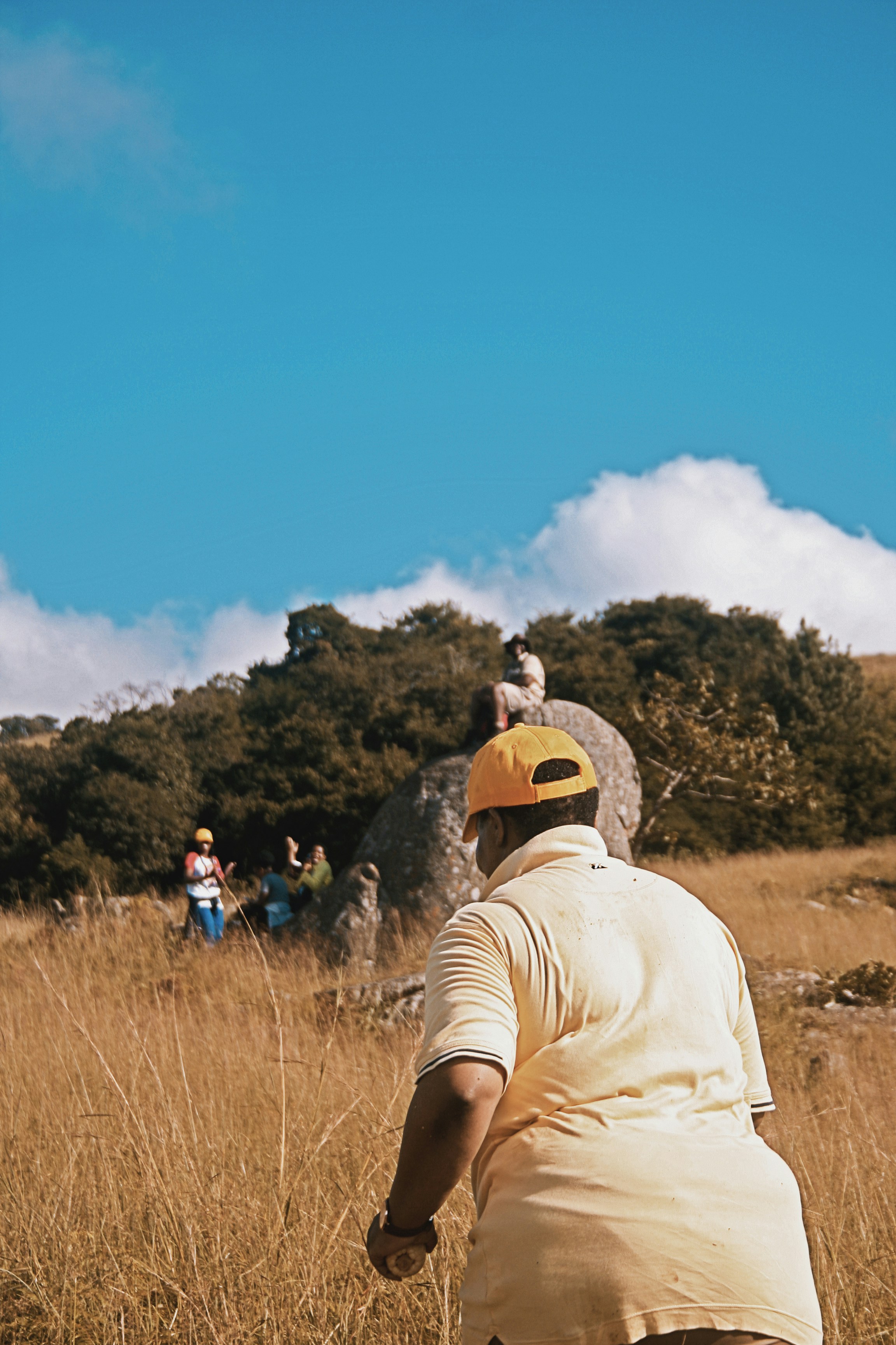 Yellow Cap Momentum: Approaching the Stone Circle in a Sunlit Field