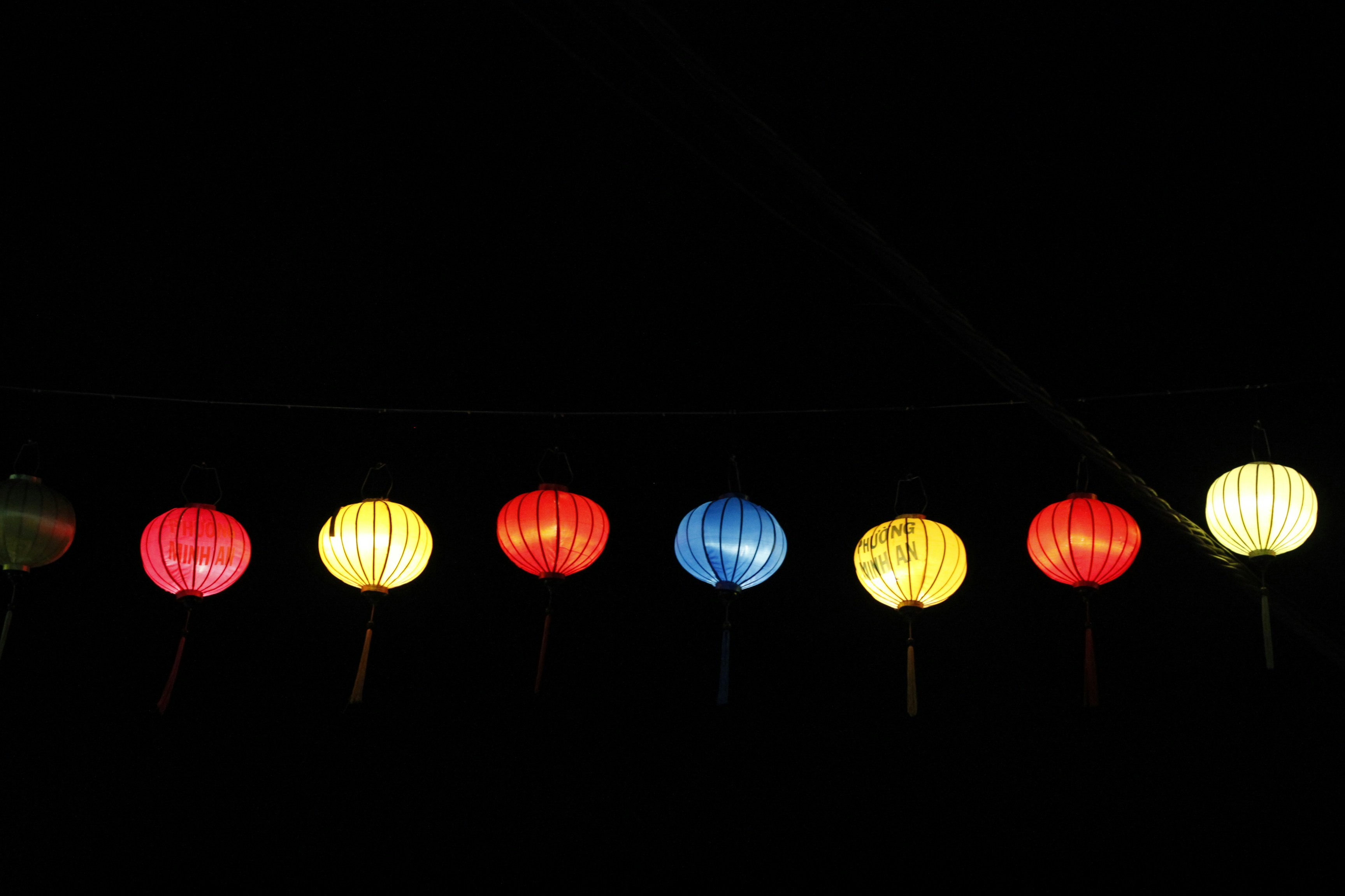 Night Parade: A Row of Glowing Lanterns Against Velvet Darkness