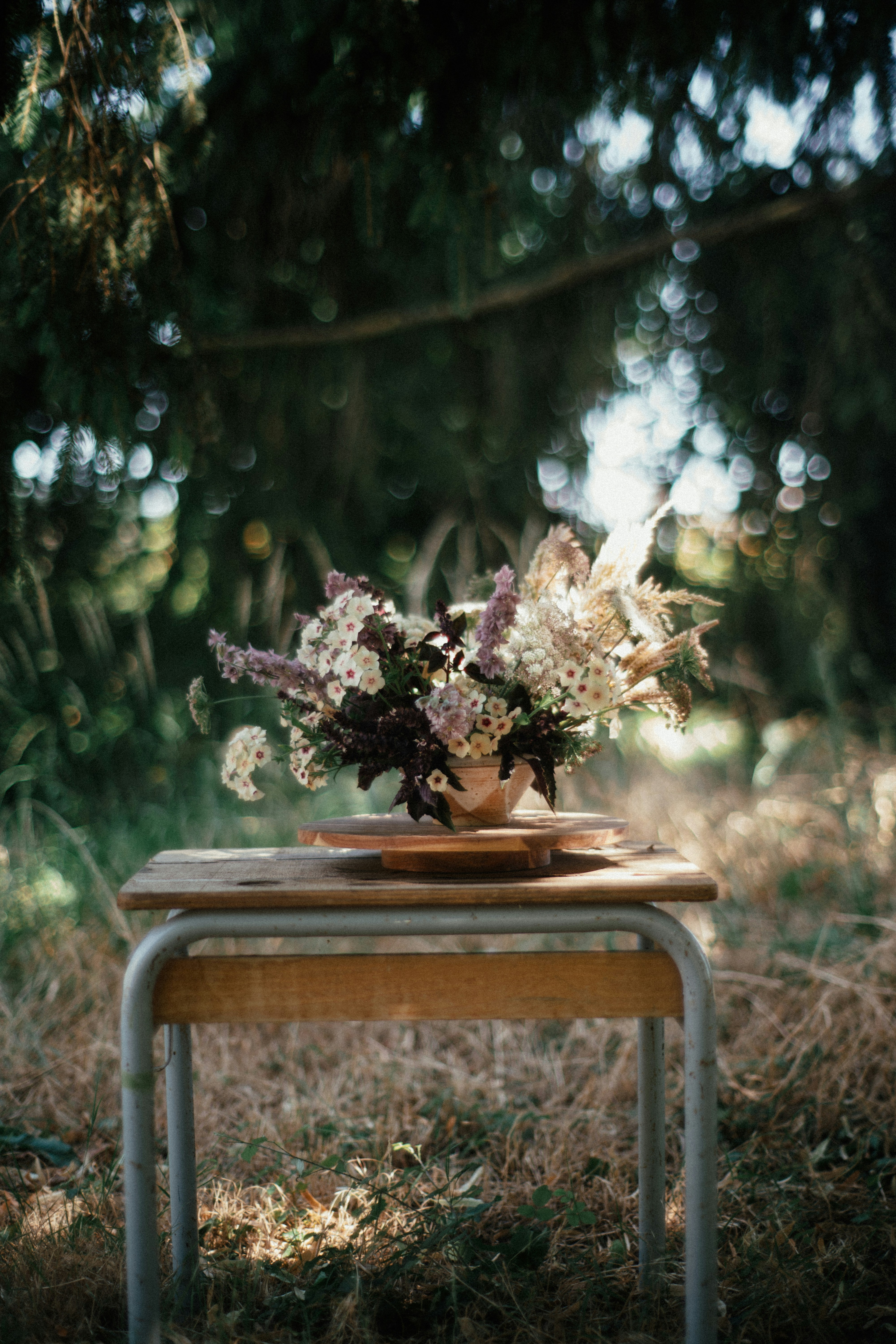 Floral Still Life on a Weathered Table in Dappled Forest Light