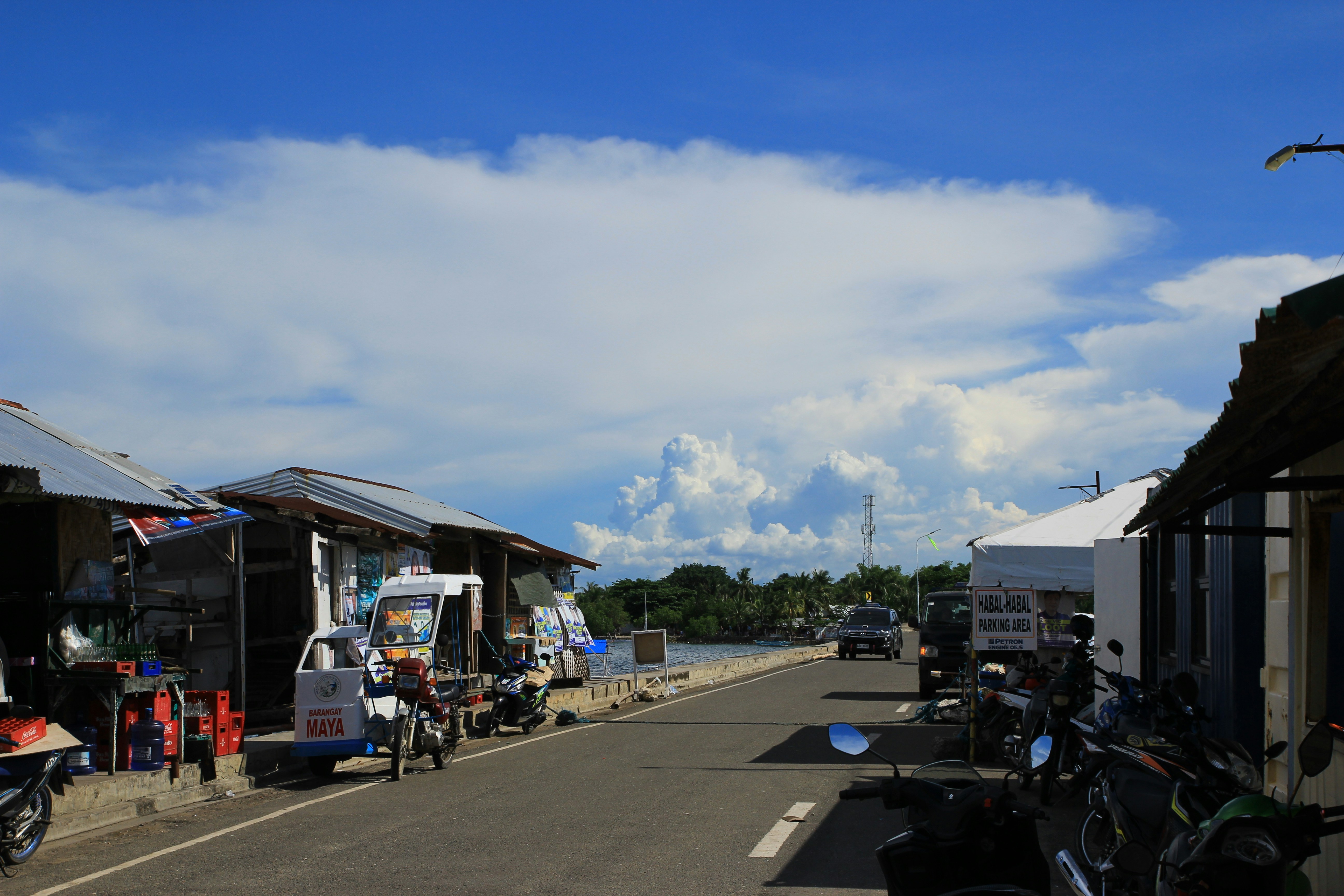 A Serene Coastal Marketplace Under a Vast Sky