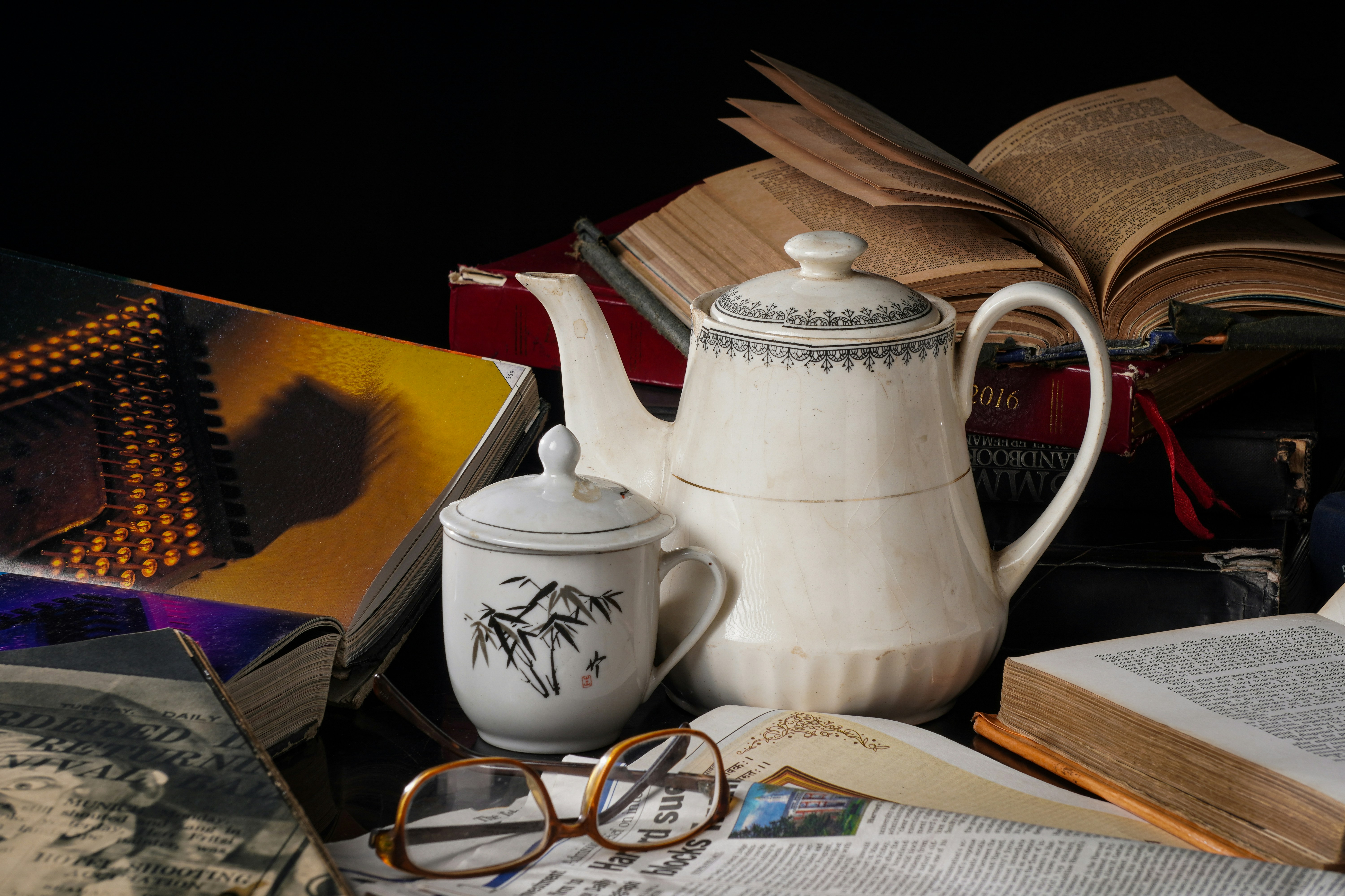 Teapot and Tomes: A Quiet Studio Still-Life Amid Open Books