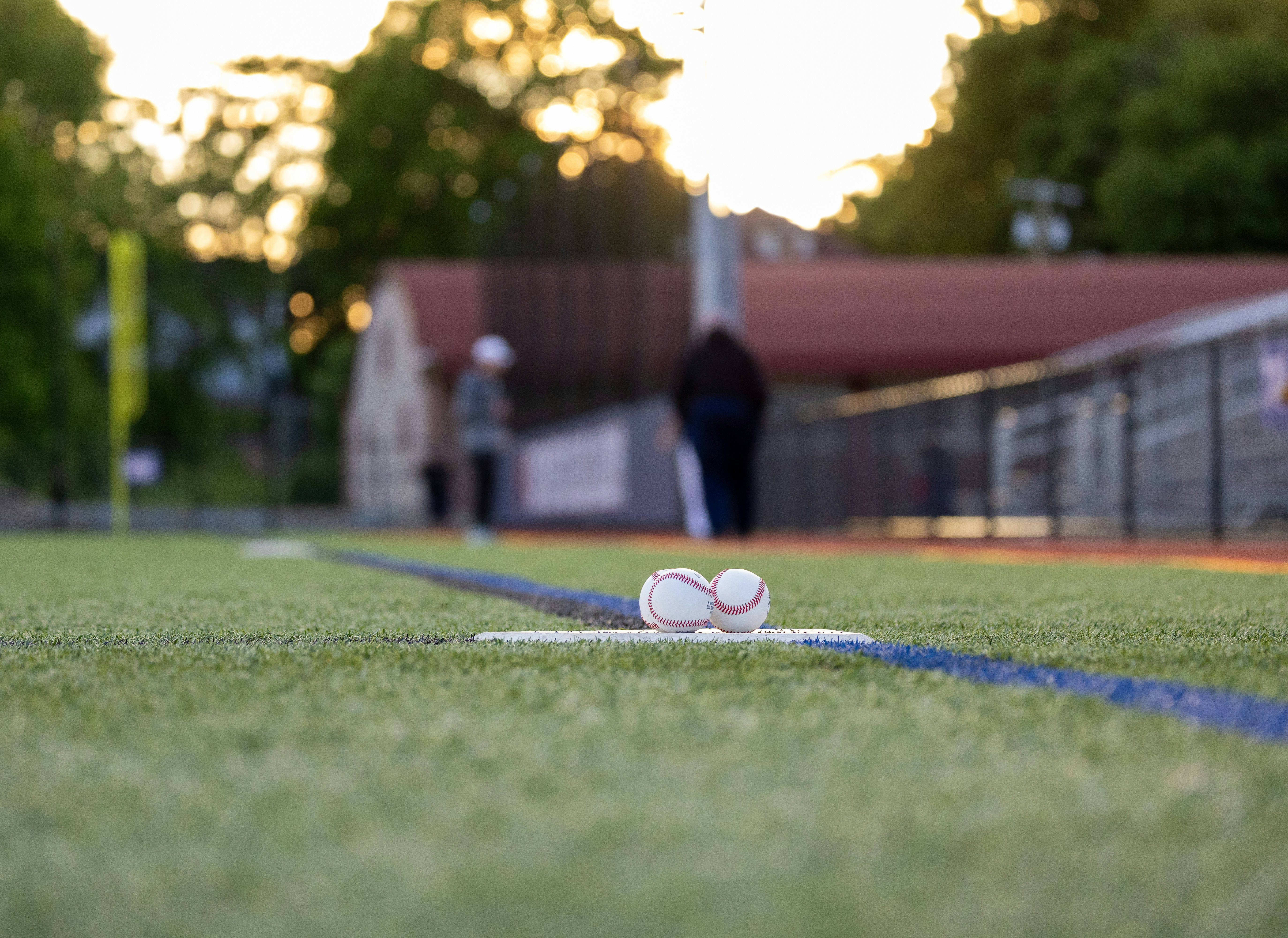 Two White Orbs on a Blue-Line Field at Dusk