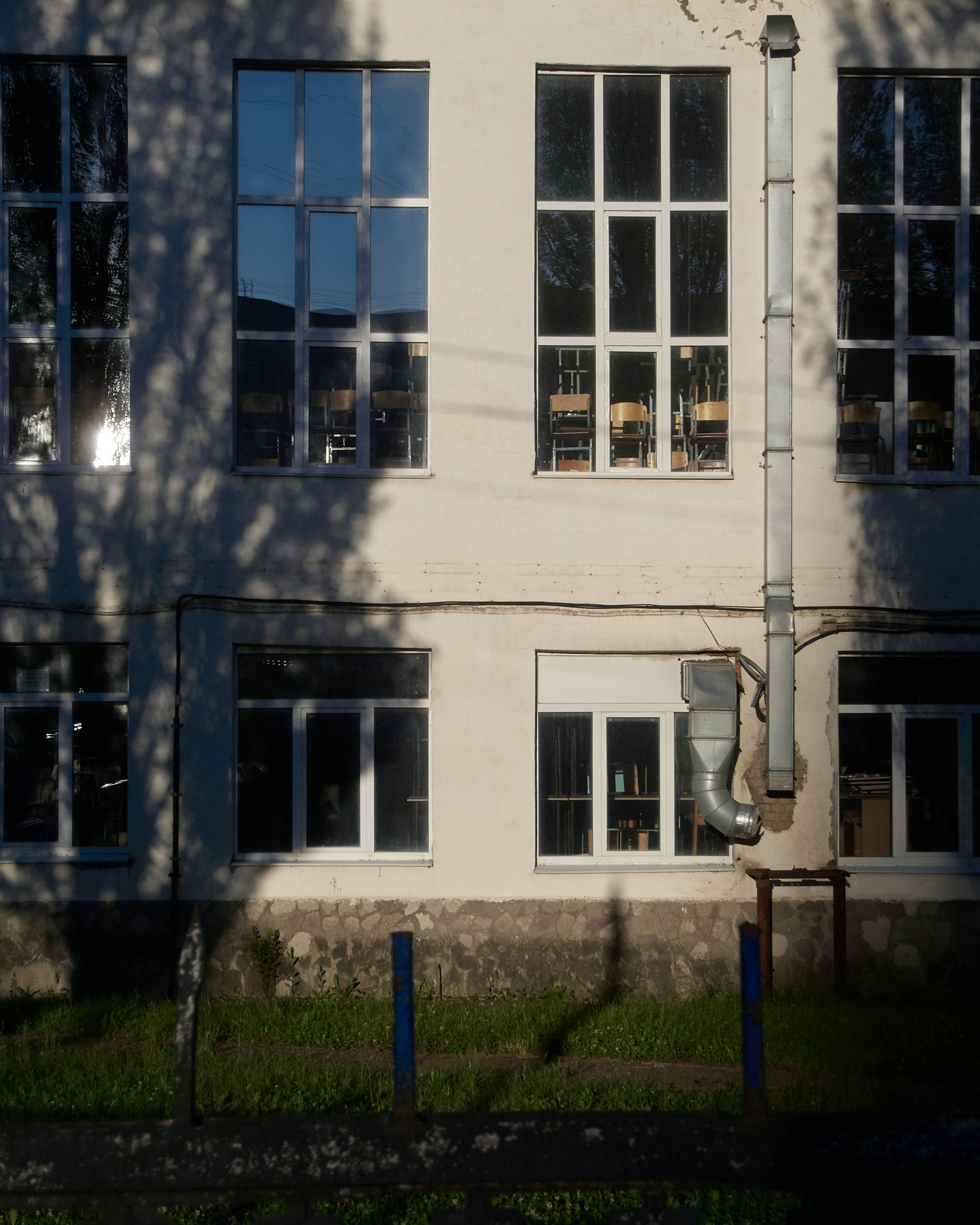 Building facade with multiple windows and shadows.