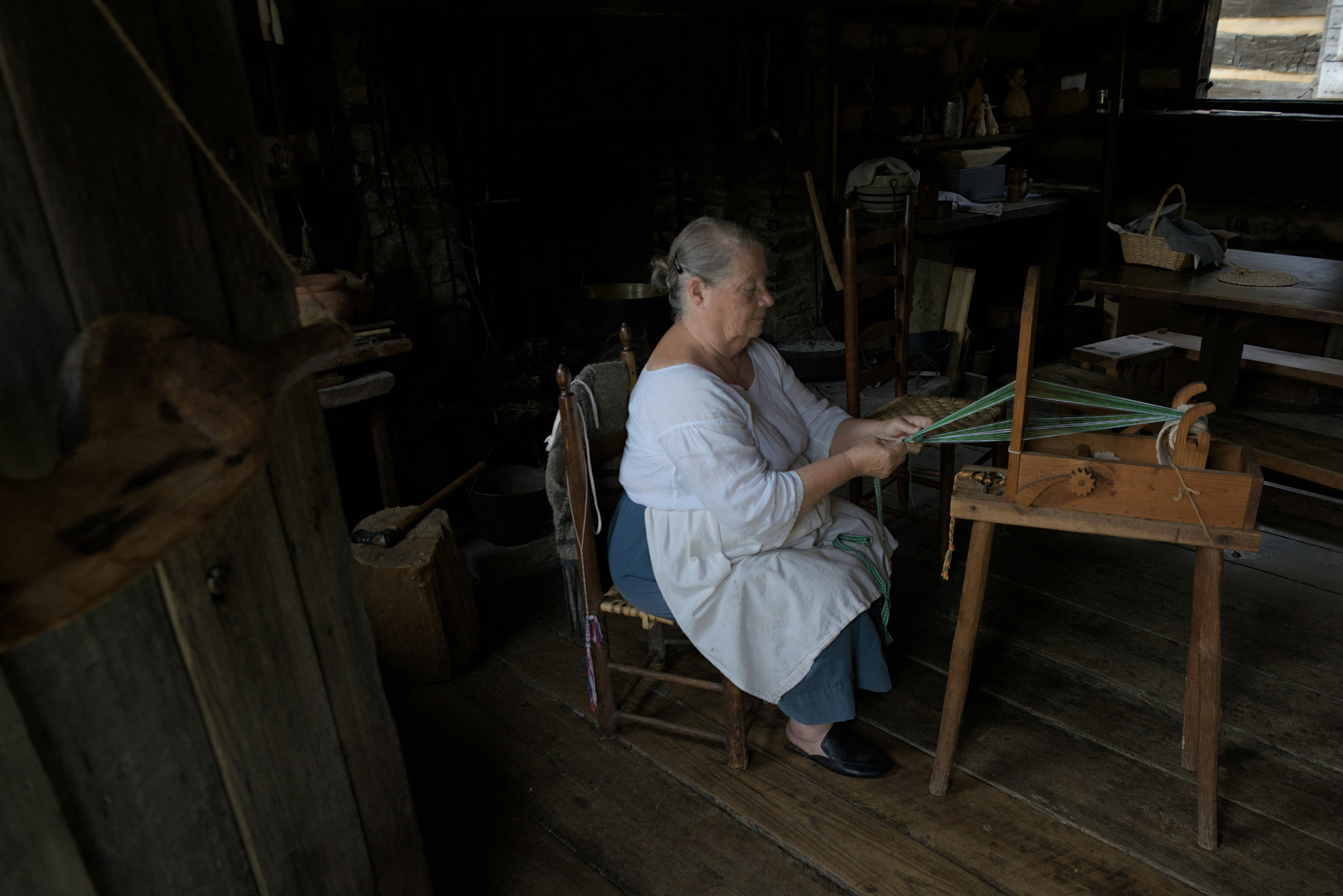 Old Hands at the Loom: A Quiet Moment in a Rustic Workshop