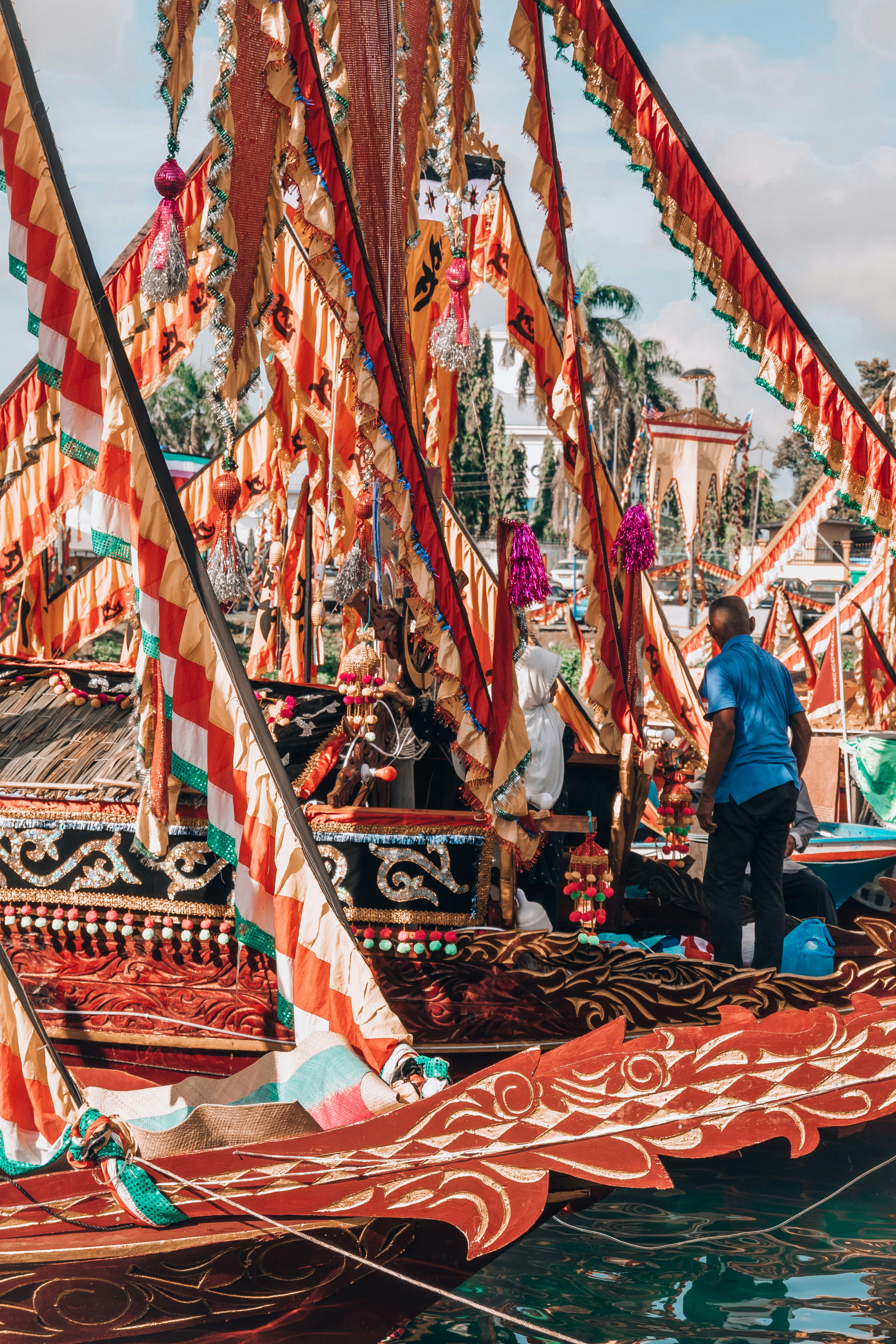 Colorful decorated boats adorned with ribbons and flags, showcasing local craftsmanship and cultural heritage during a festive event.