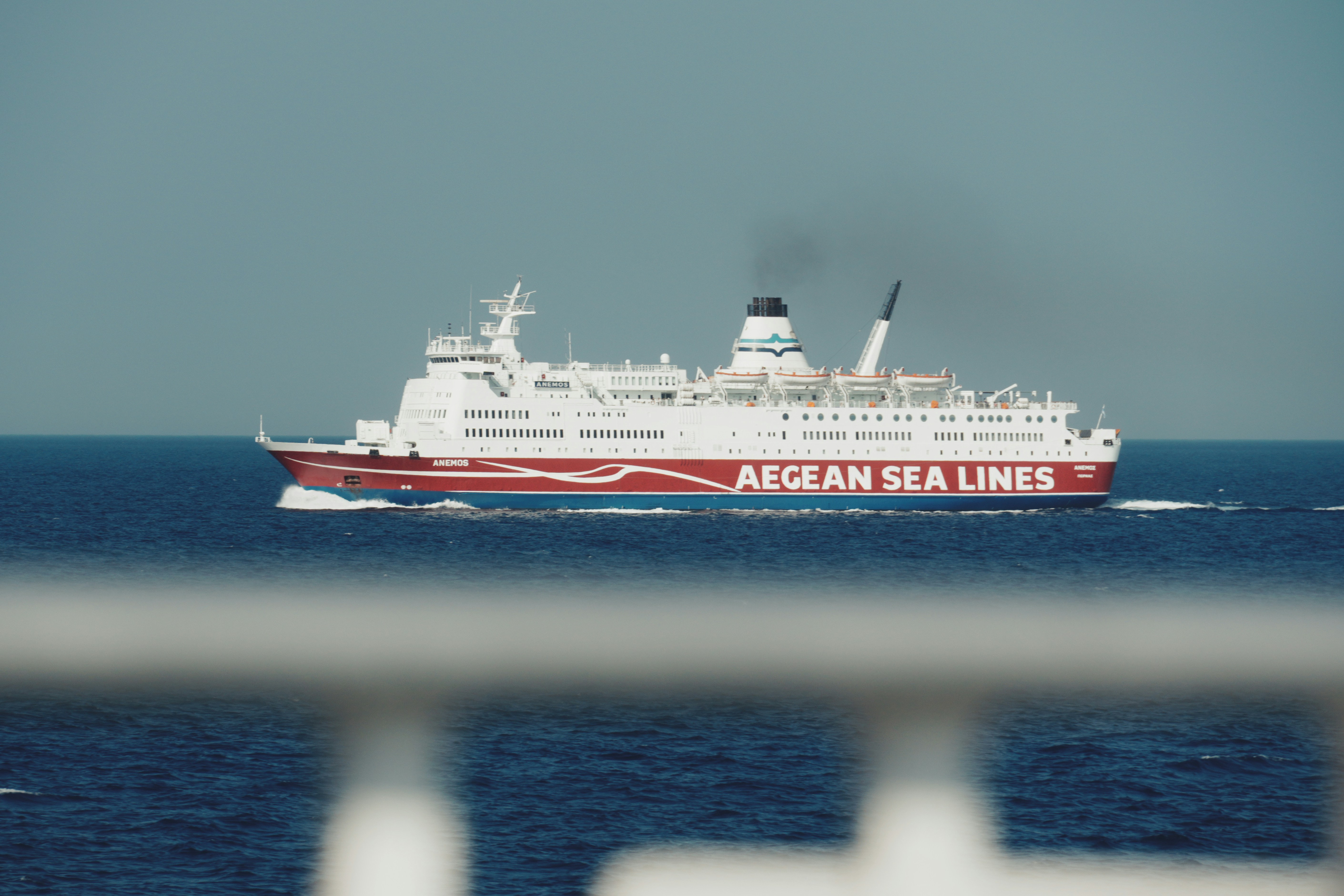 Red Hull on Aegean Blue: A Ferry's Quiet Crossing