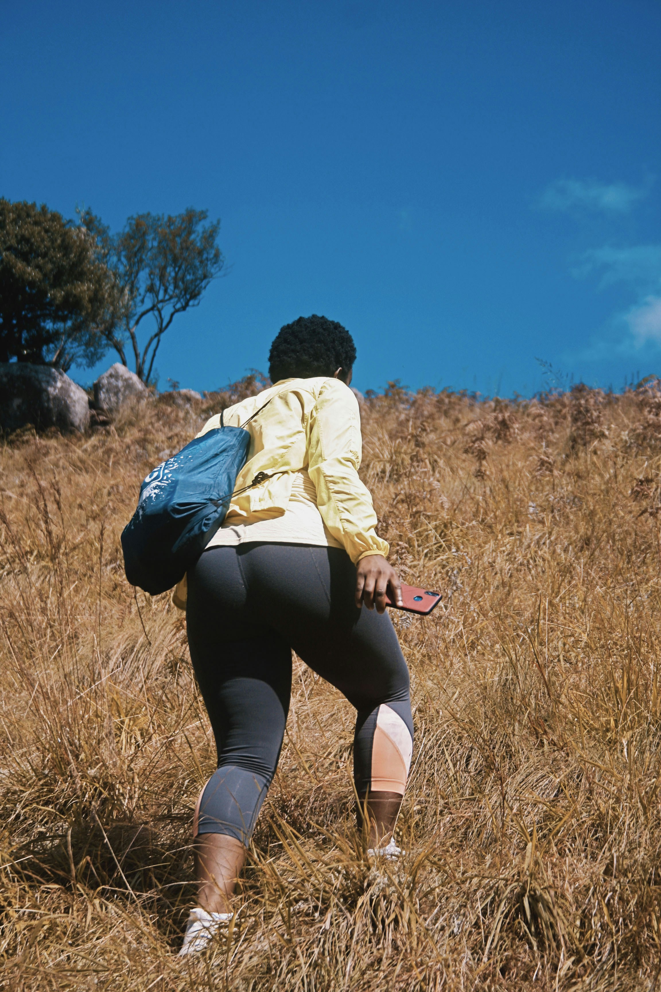 Backview Ascent: Chasing the Sun Over a Golden Hill