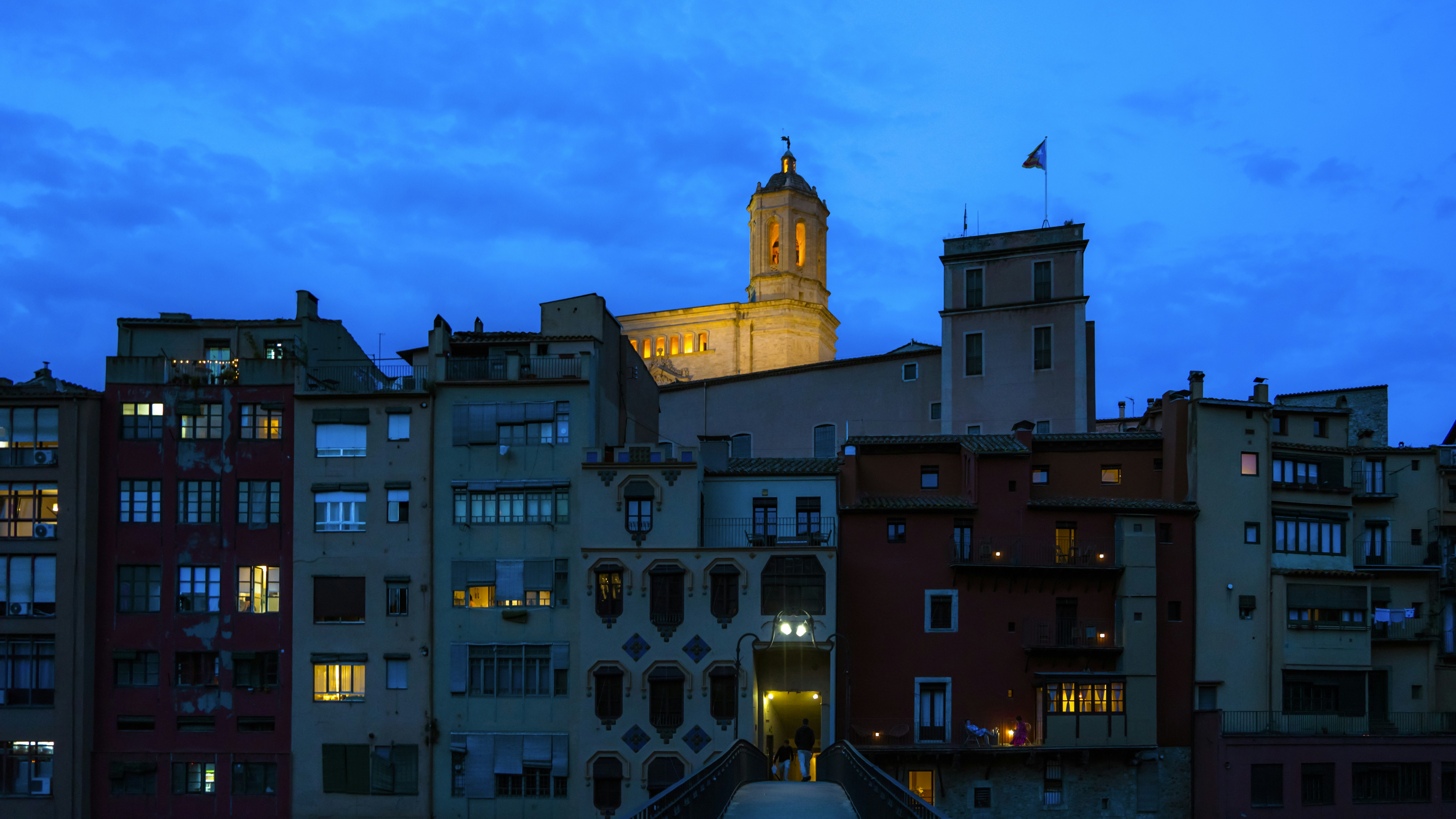 Buildings illuminated at twilight with a cathedral.