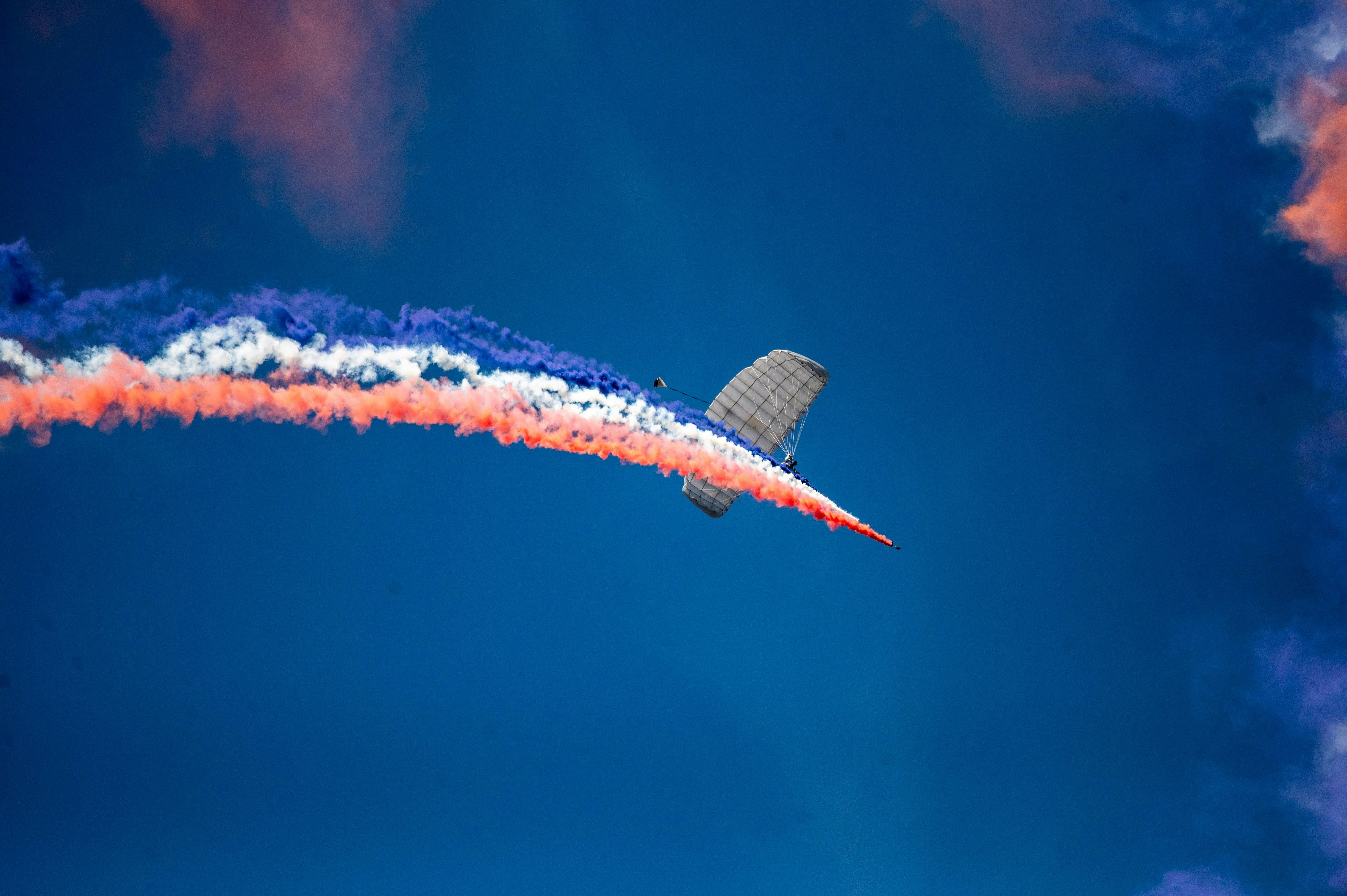Smoke Trail of a Skyward Flame: A Lone Glider Carves a Red Path
