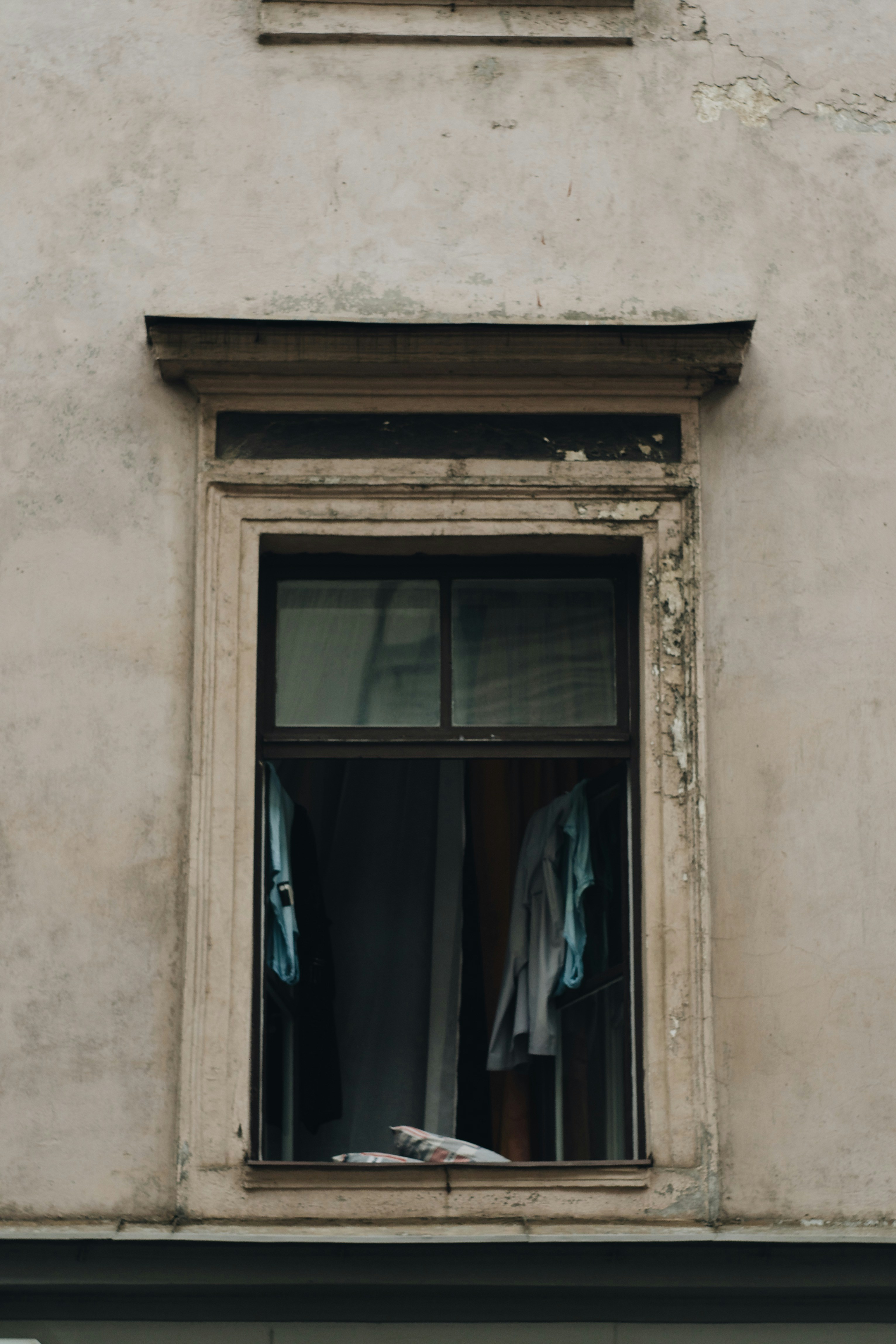 An open window with clothes hanging inside.